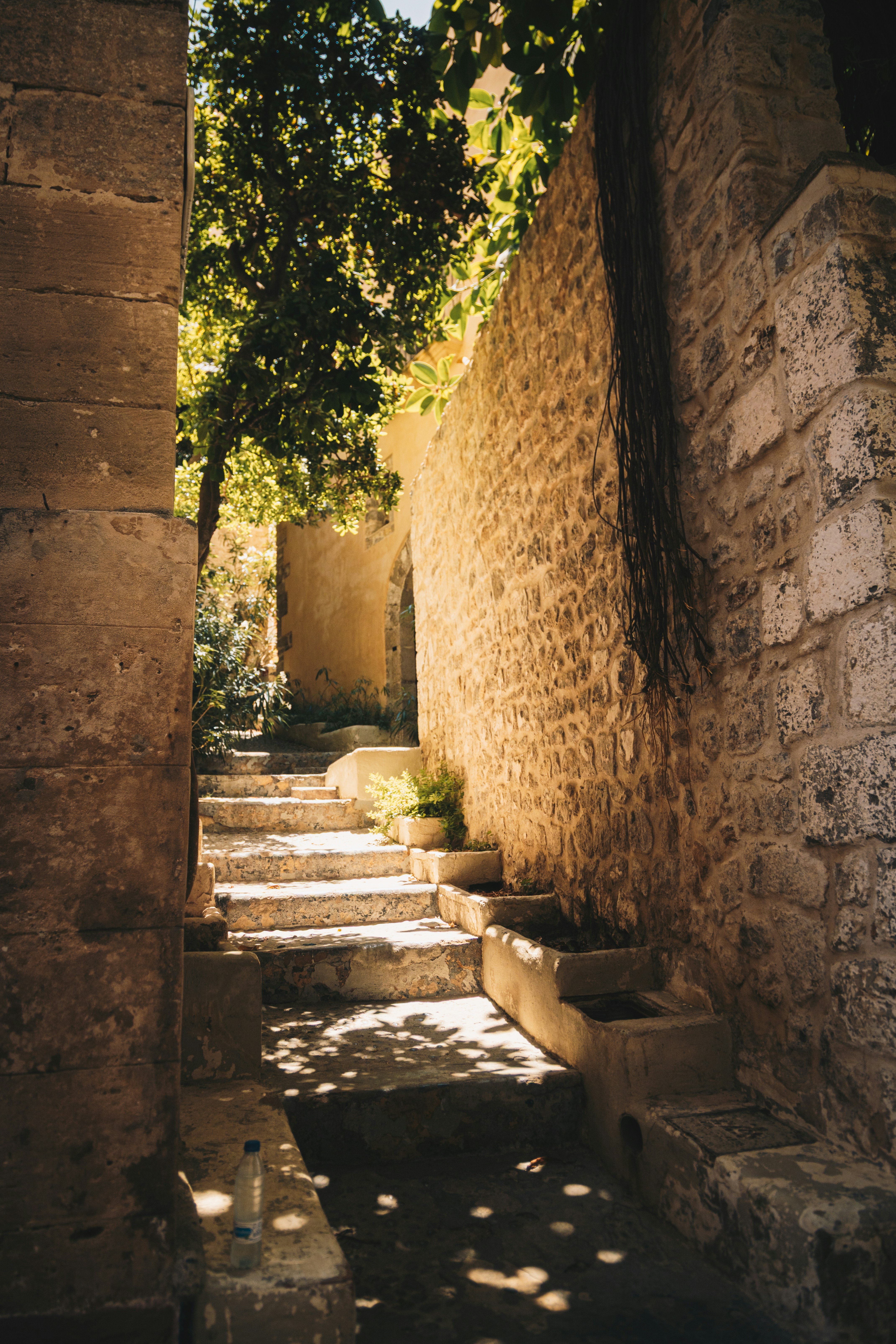 Sunlit Terrace Steps Between Aged Stone Walls