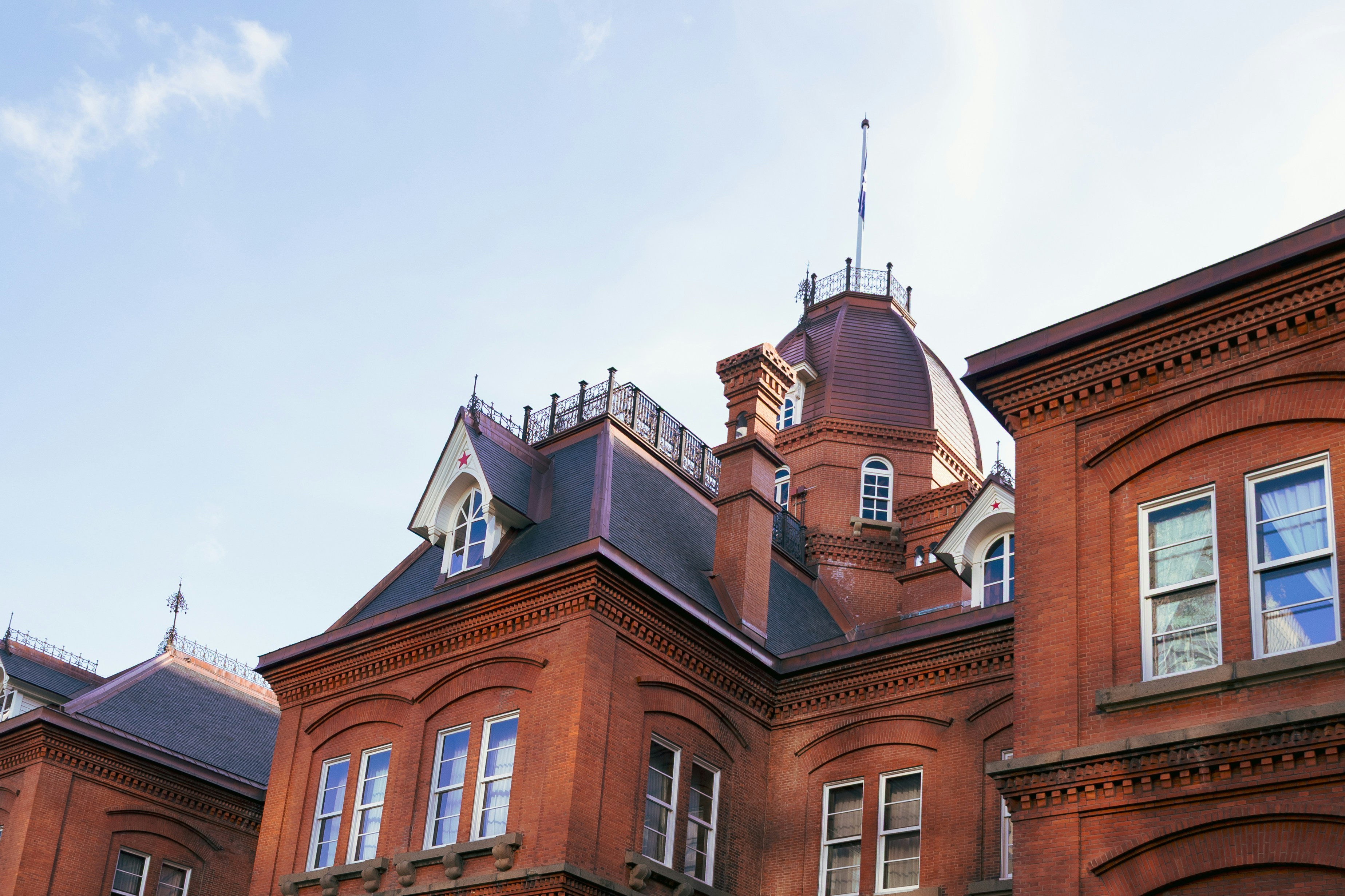 Brick Gothic Rooflines Under a Quiet Blue Sky