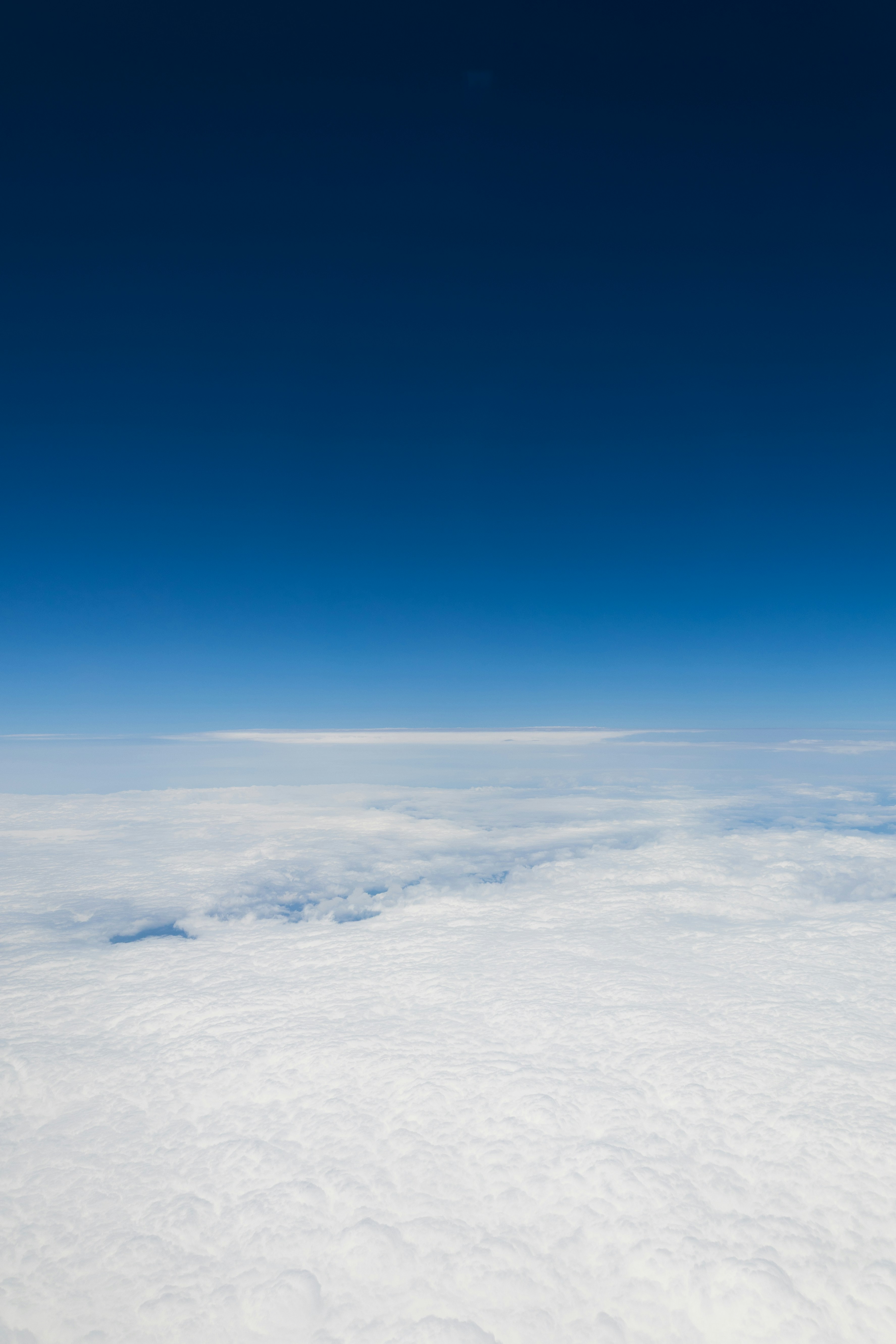 Above the Clouds: A Clear Blue Horizon