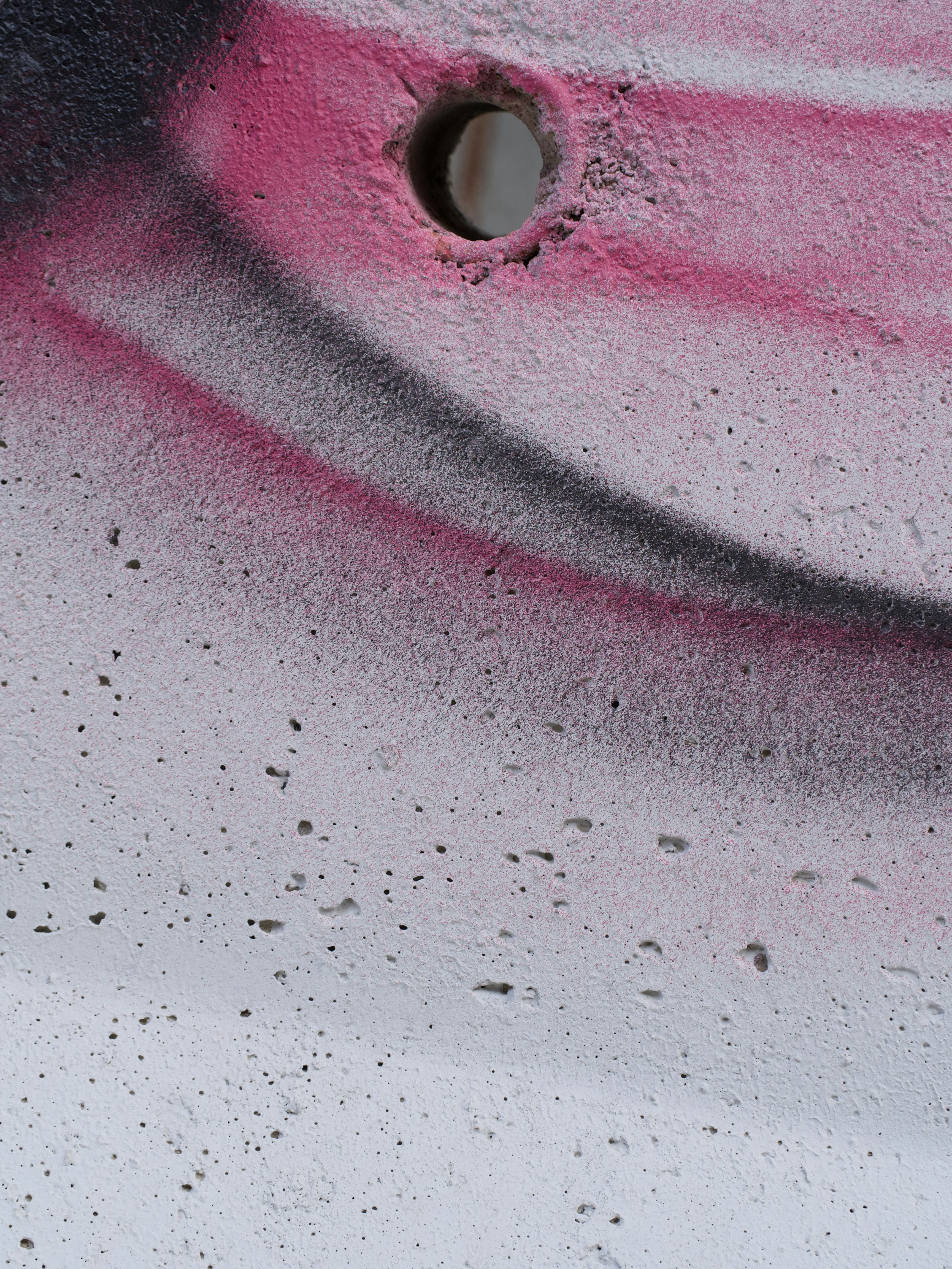 Graffiti Ring: pink haze over a weathered concrete surface