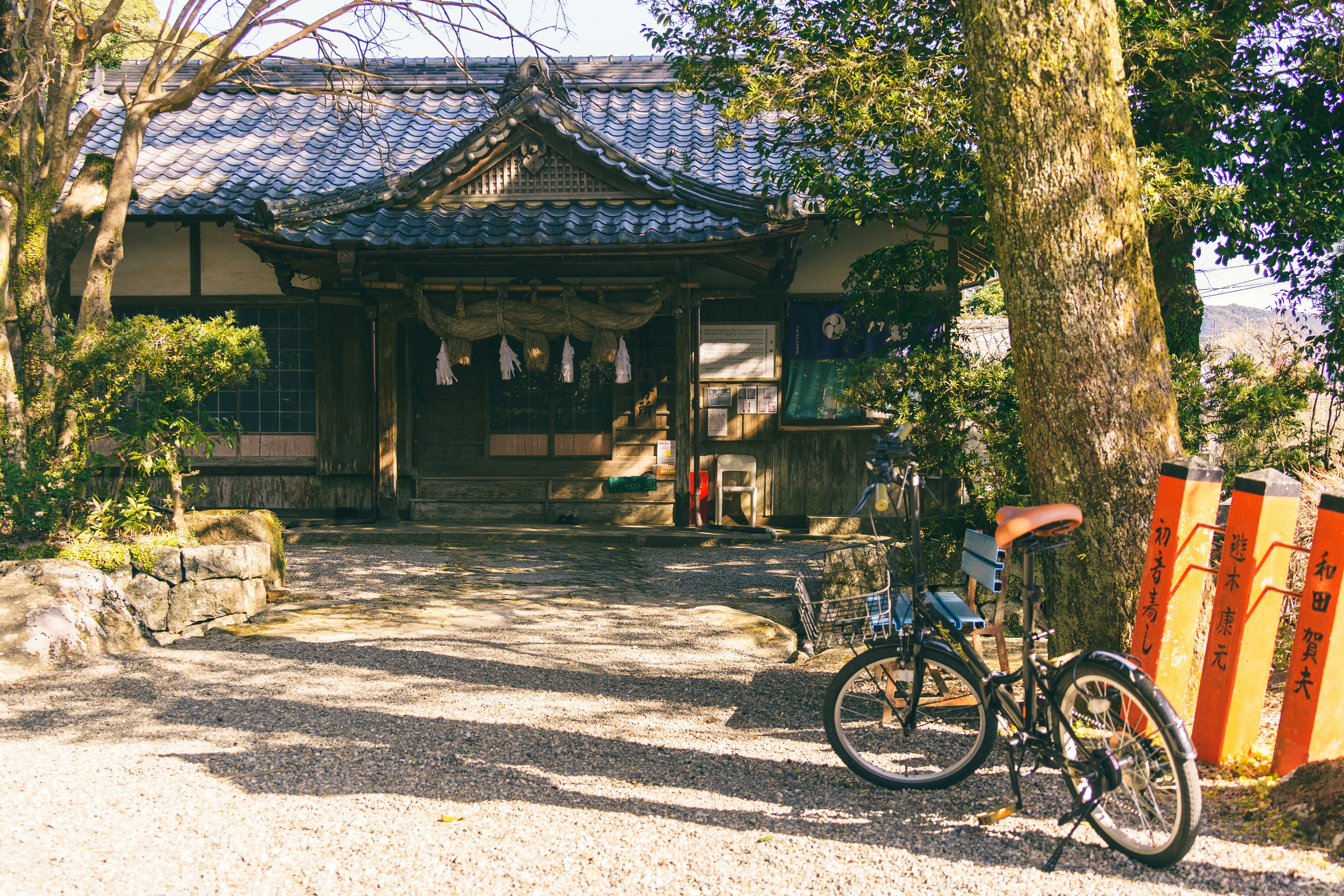 Quiet Shrine Court with a Parked Bicycle Framing the Gate