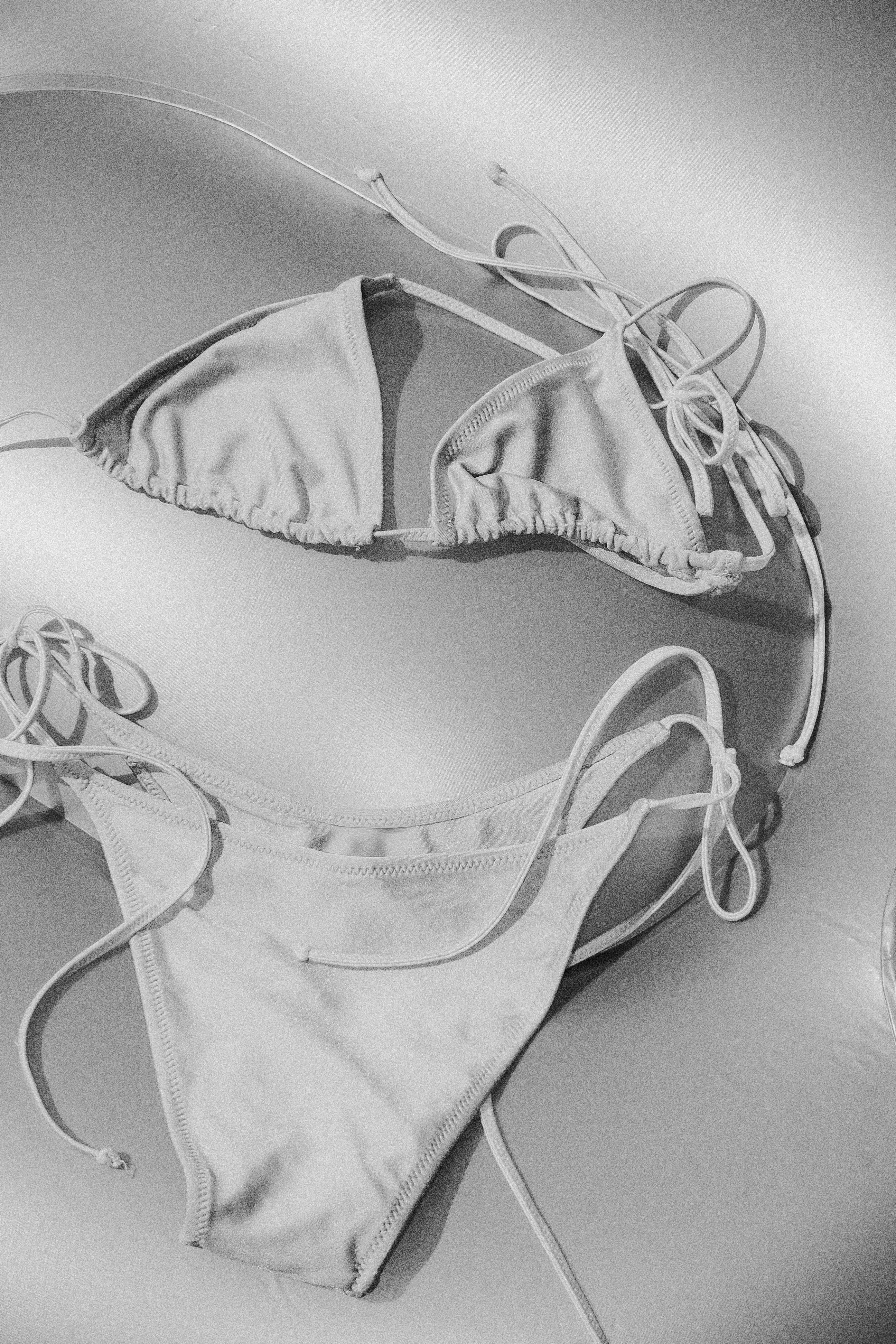 Sunlit Isolation: A Bikini Set Resting on a Curved Surface