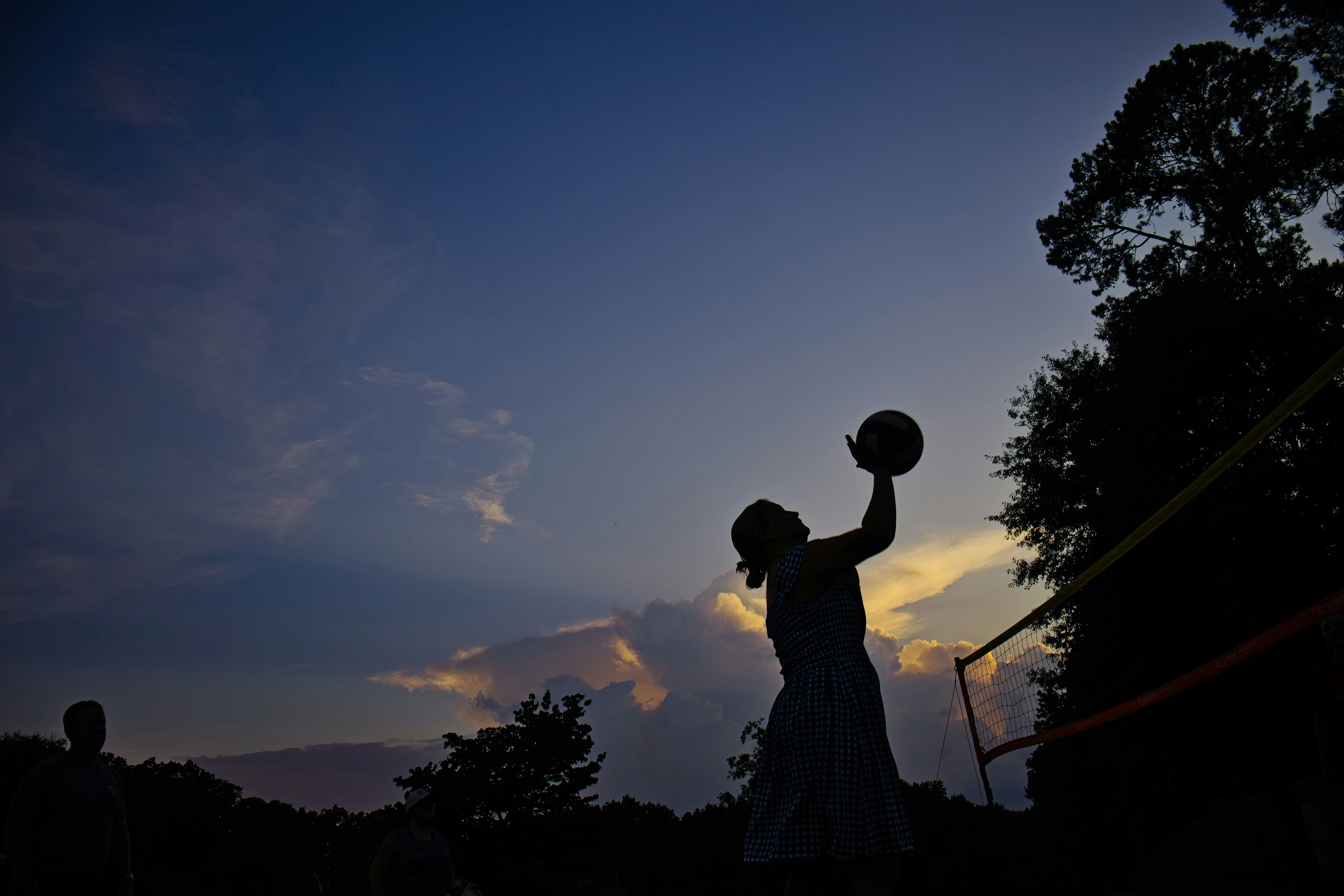 Silhouette at Sunset: A Lone Figure Unleashing the Ball