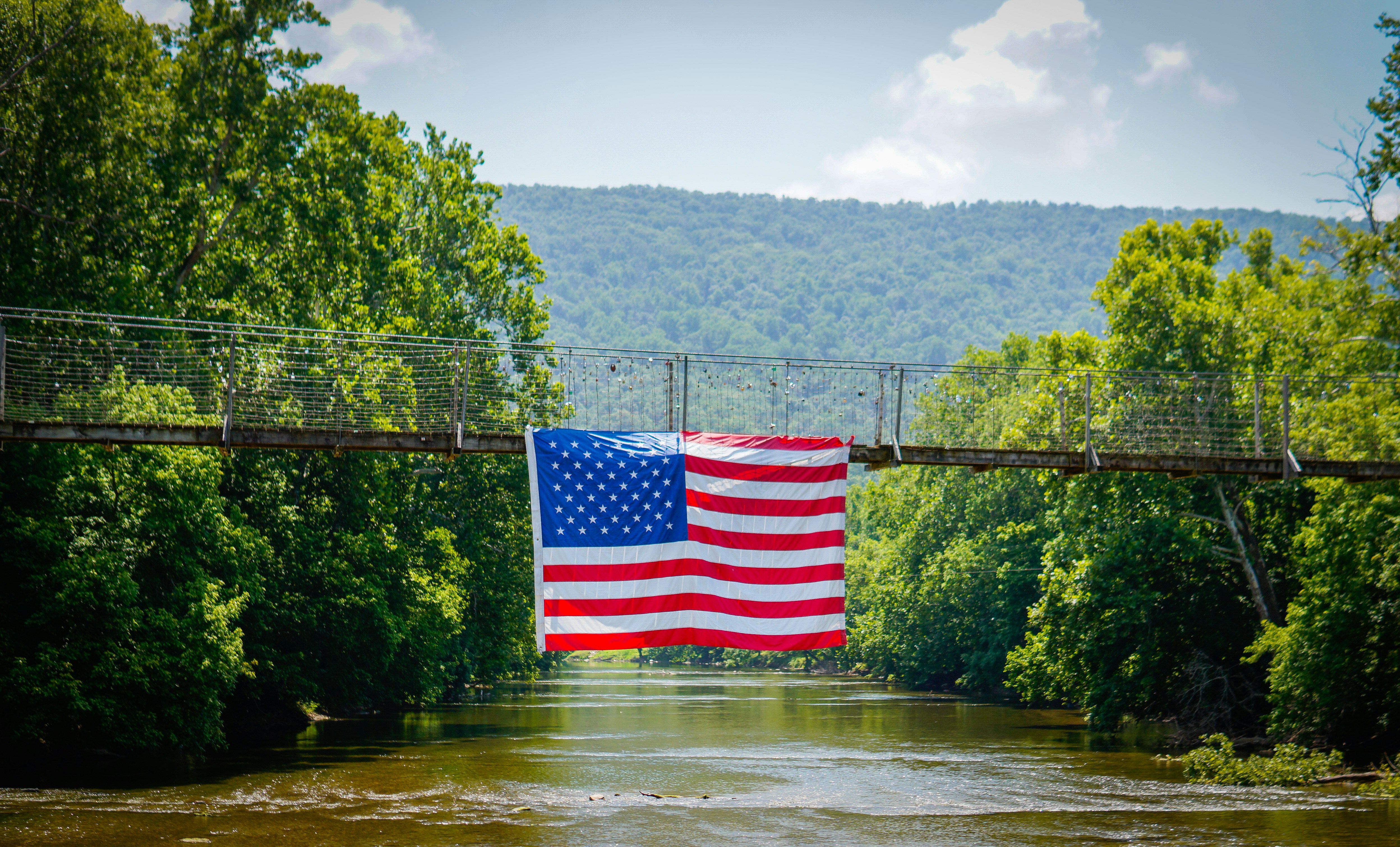 Flag over the River: The Quiet Apex on a Suspended Bridge