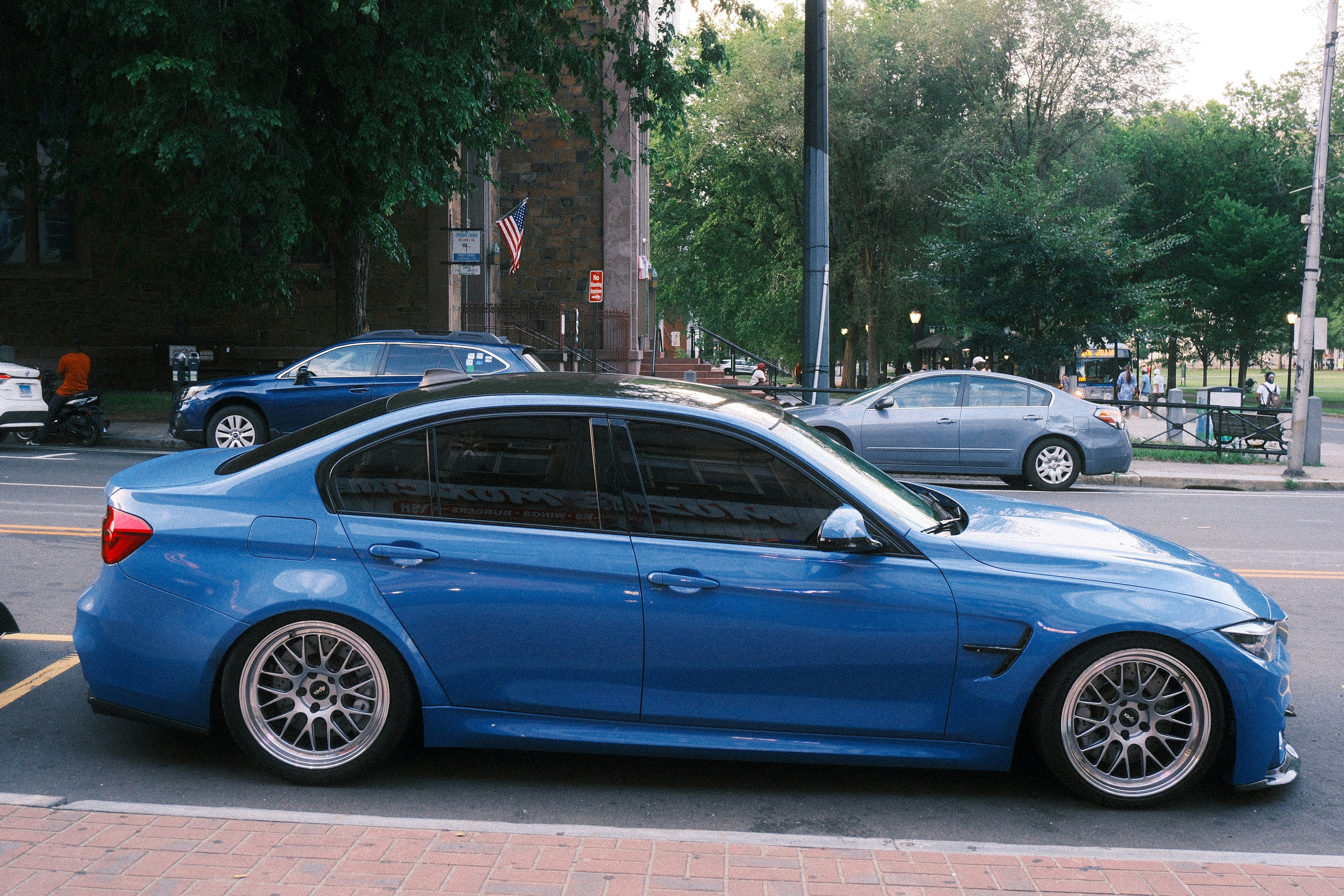 Blue Beast: A Stanced Sedan Rests Along an Urban Street