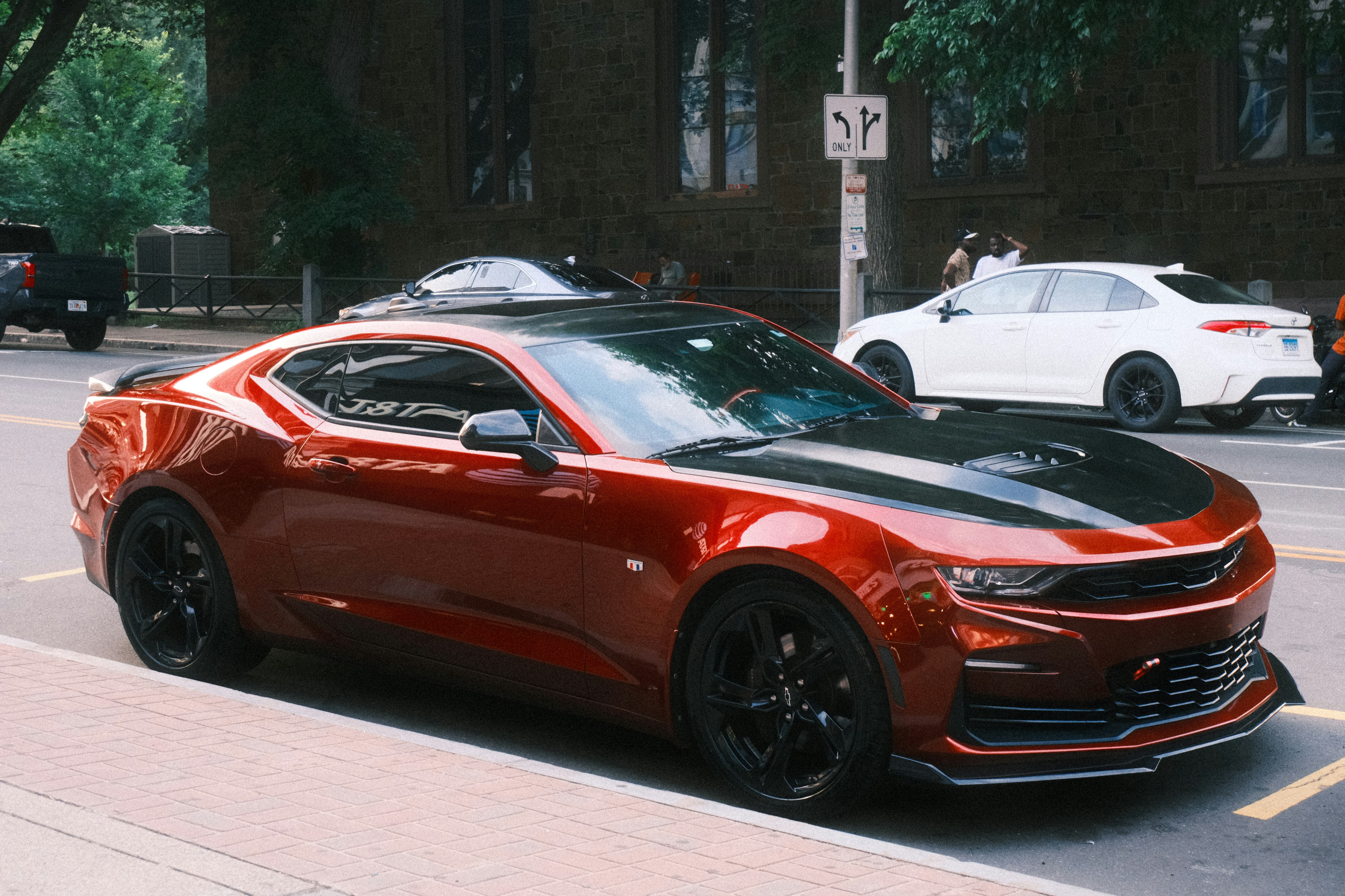 Crimson Velocity: A Red Challenger Resting on a City Street