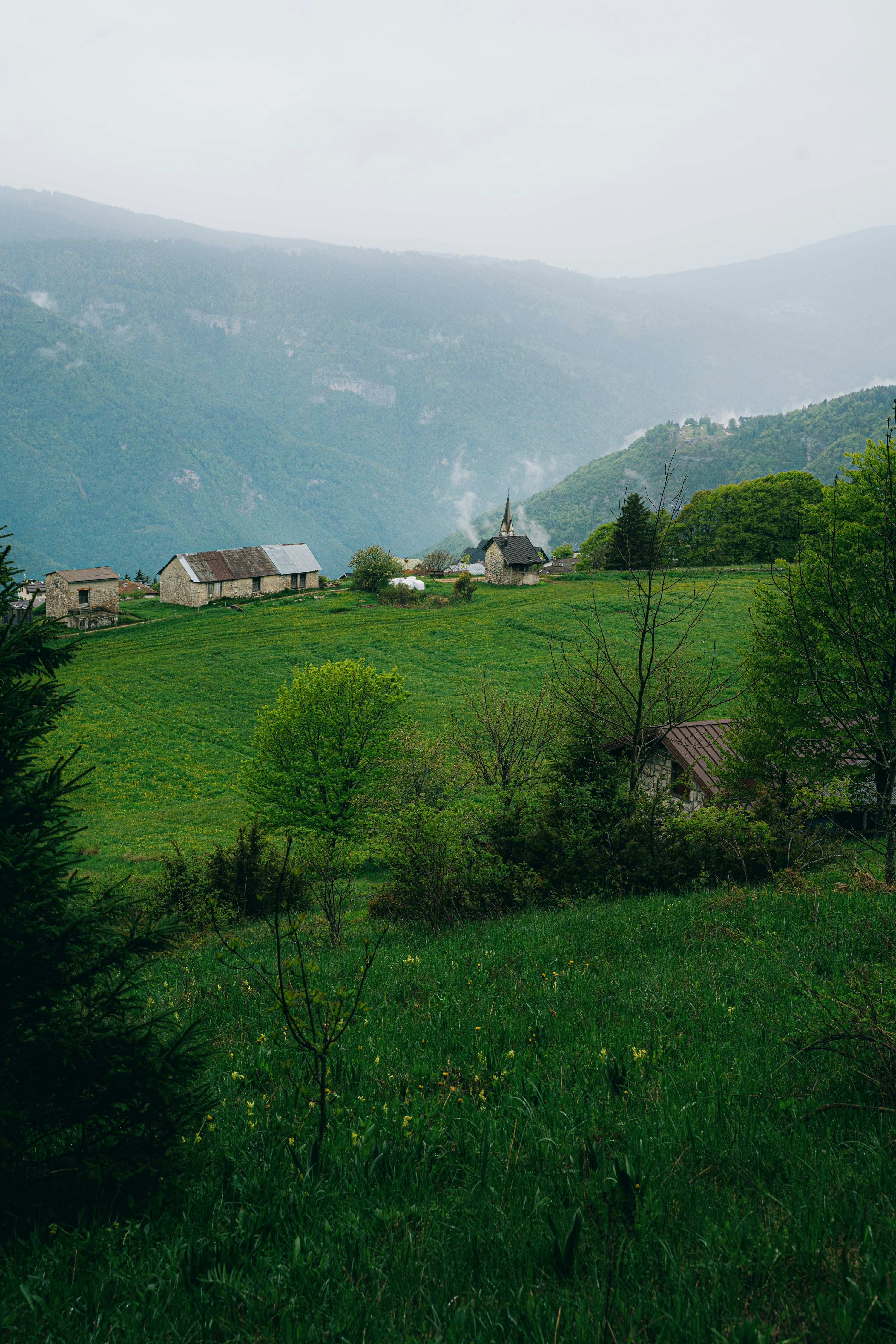 Pastoral Village Beneath Misty Valleys