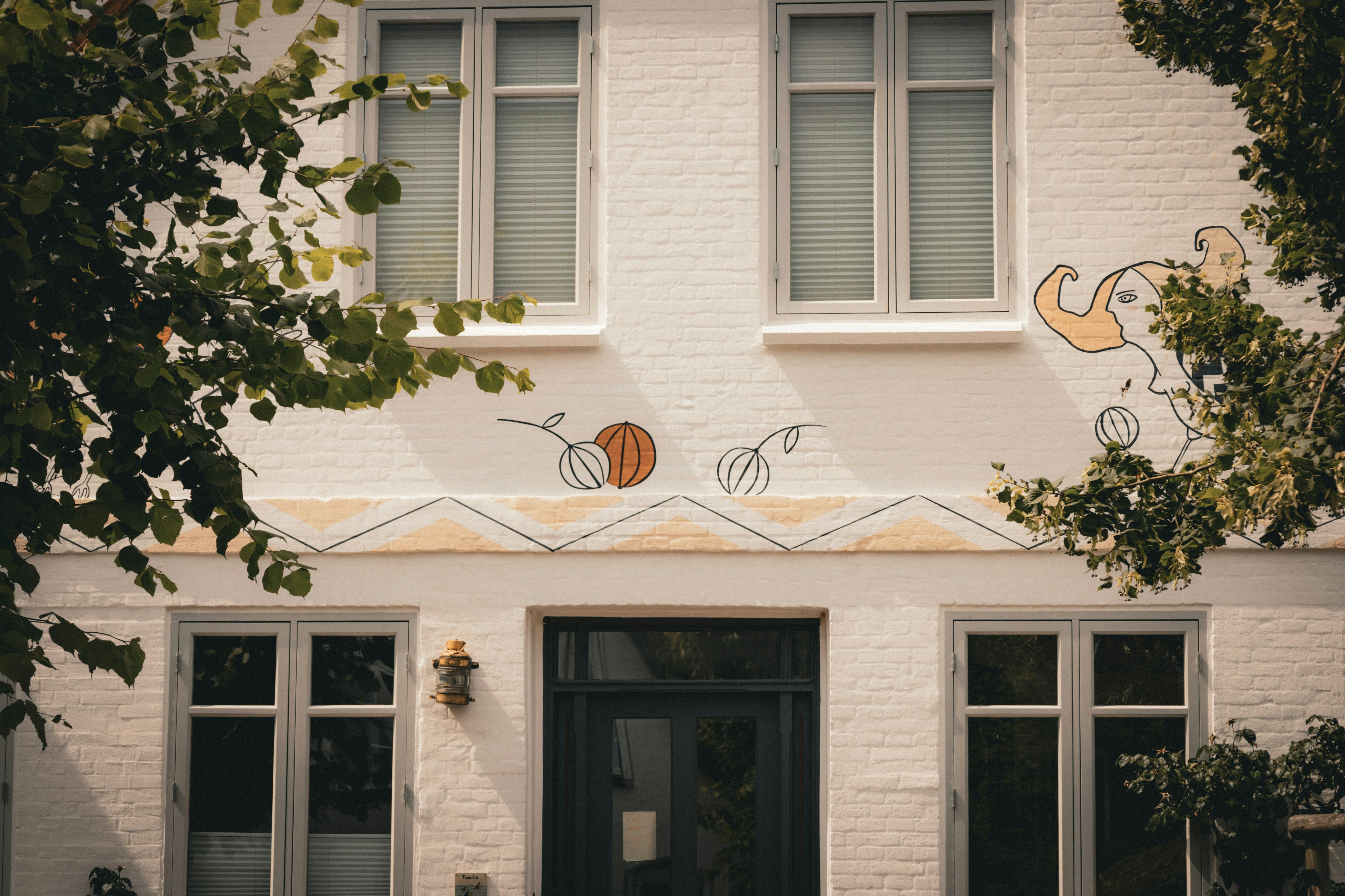 Pastel Facade with Whimsical Wall Art