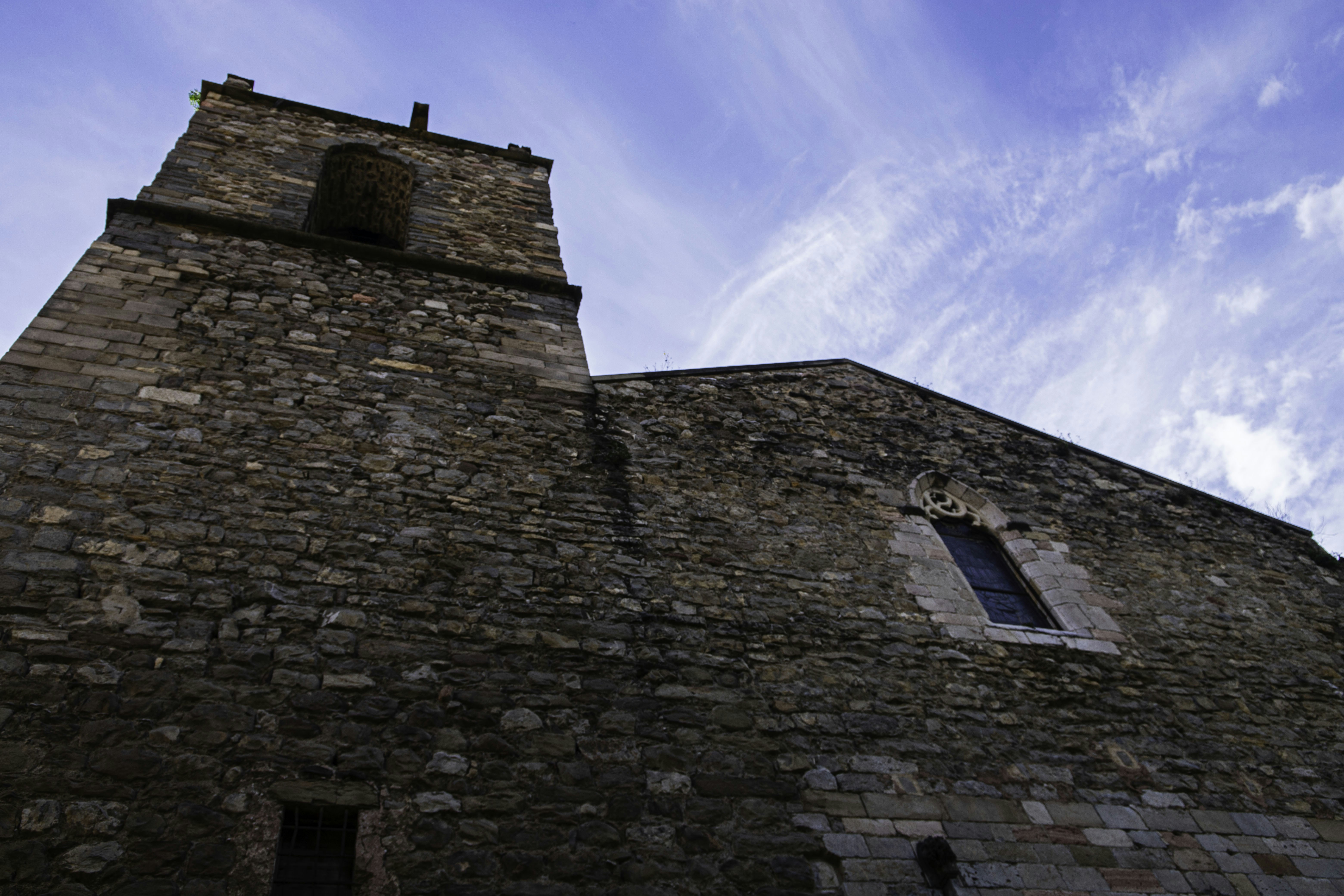 Stone Bell Tower Against a Bright Sky