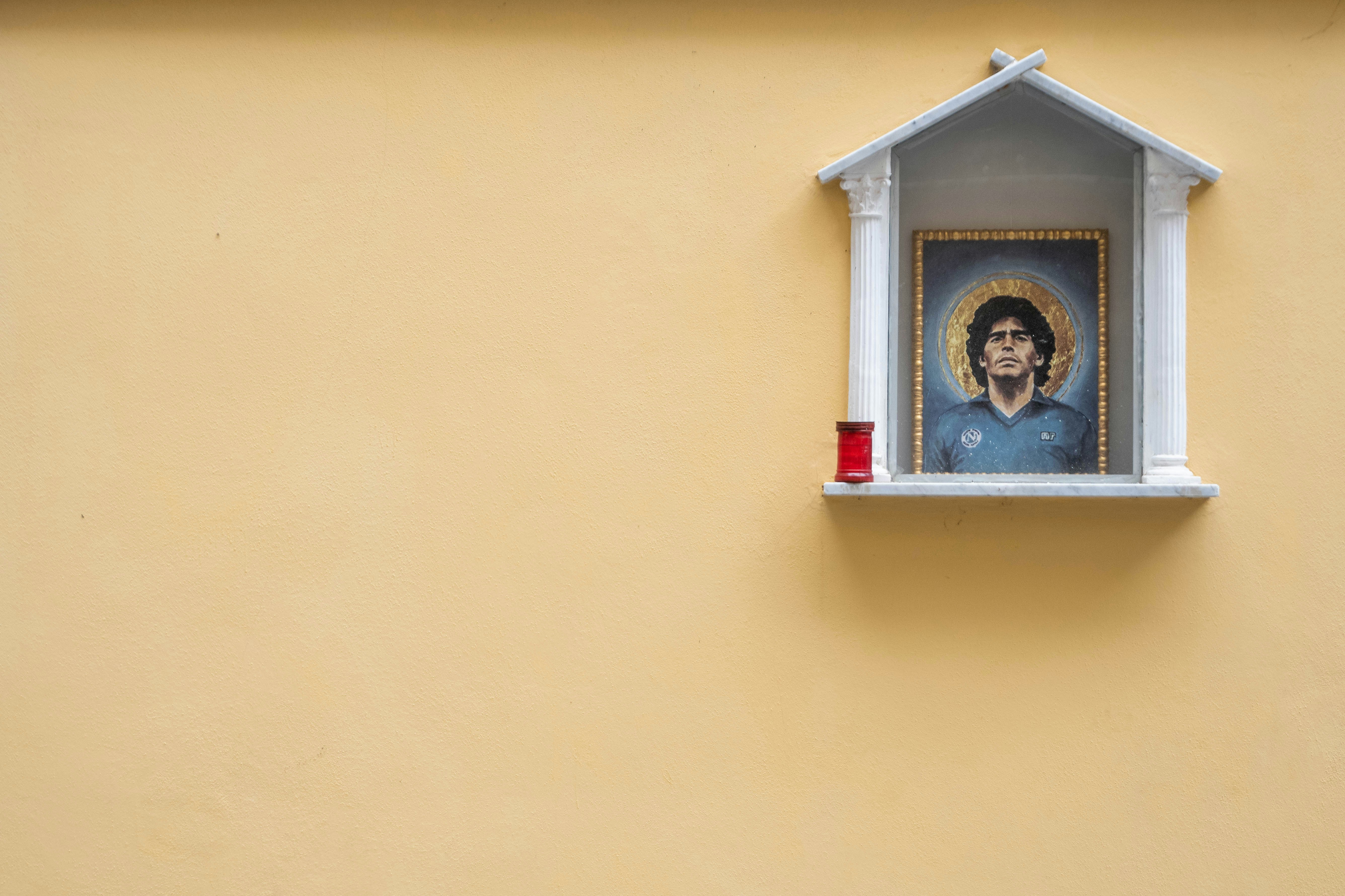 Saintly Shrine on a Sunlit Yellow Wall
