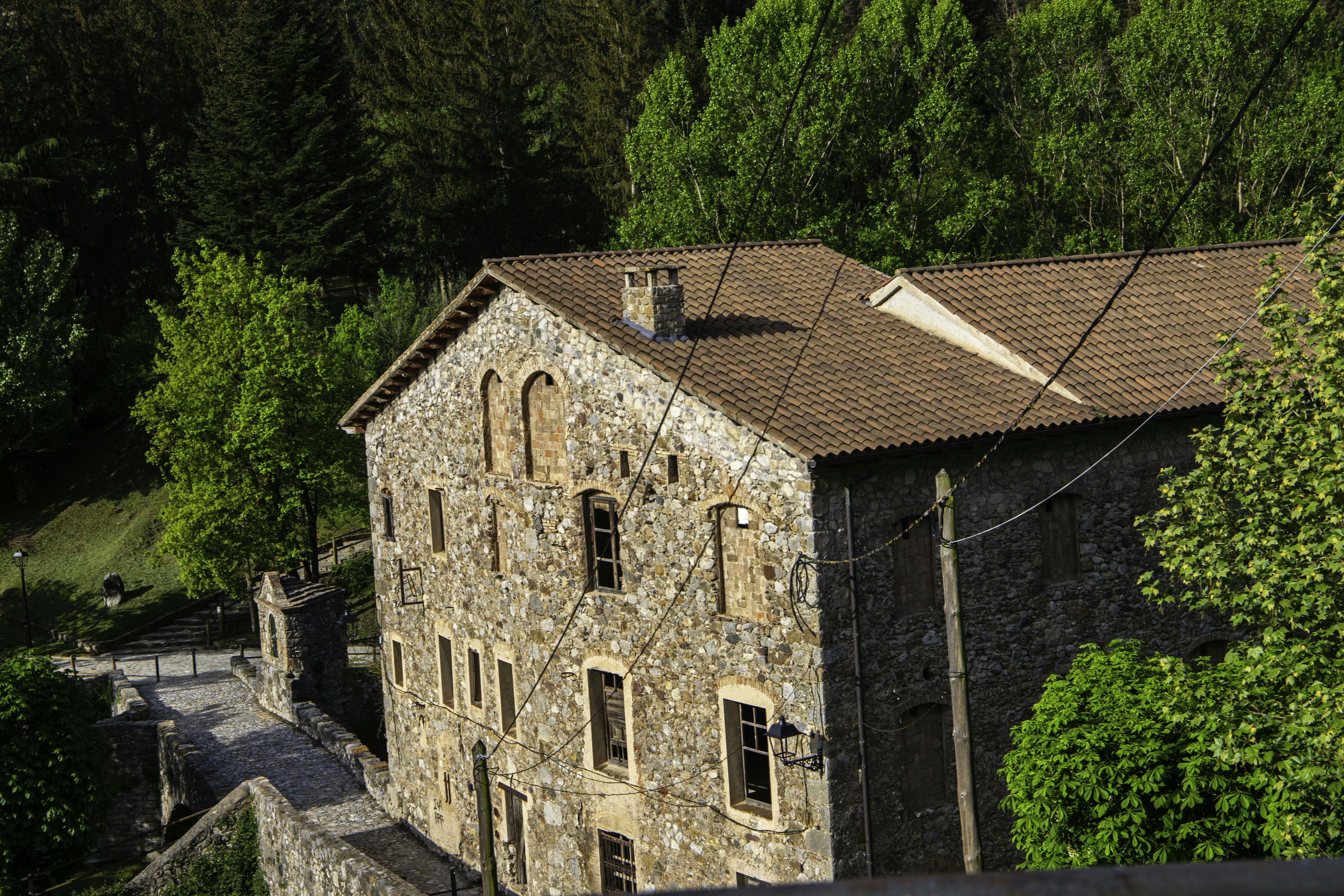 Stone Mill House Rises Amid Verdant Retreat