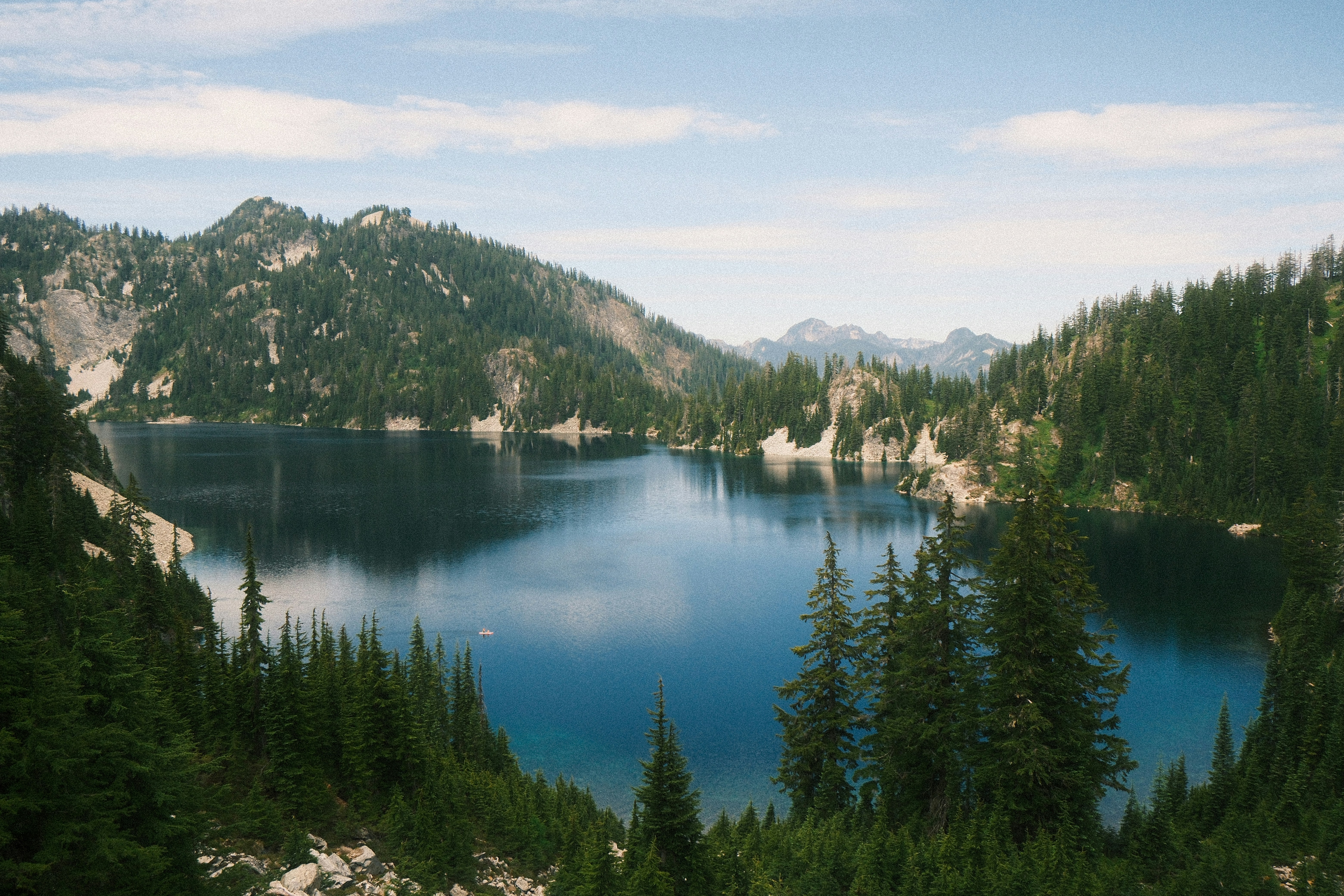 Azure Crater: A Serene Mountain Lake Framed by Pine Forest