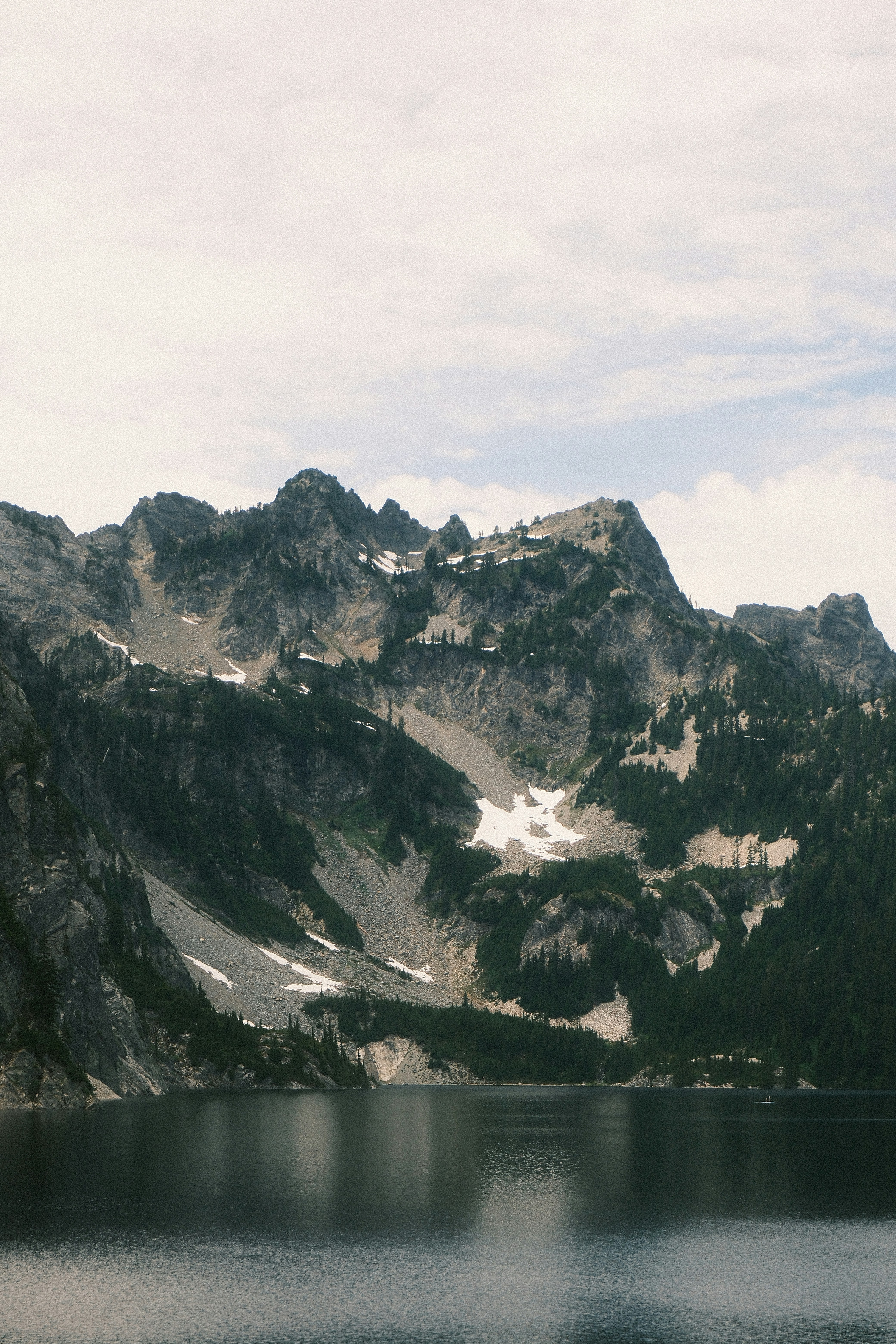 Snow-dusted peaks over a tranquil alpine lake