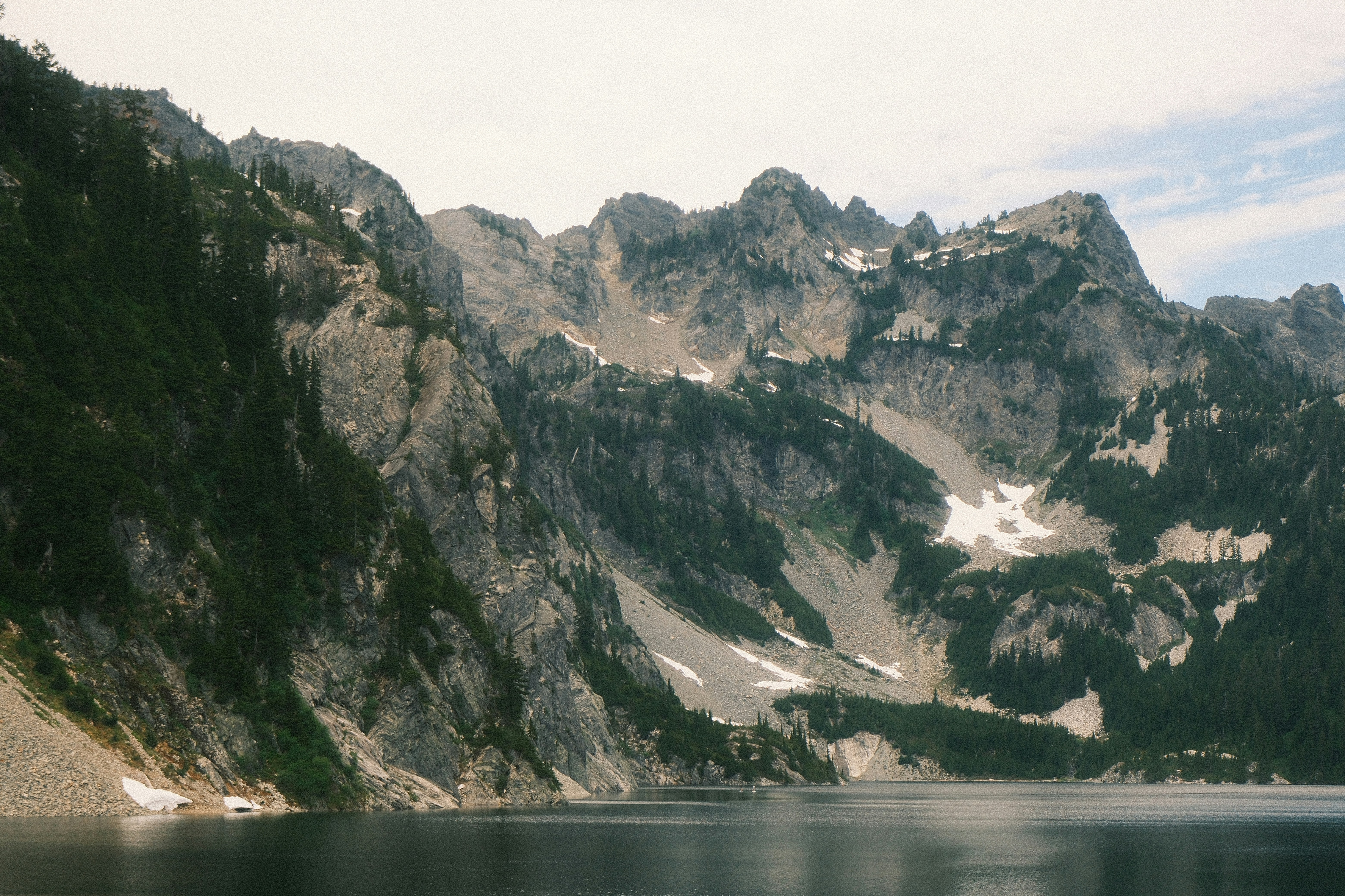 Glacial Rim Reflections over a Quiet Alpine Tarn