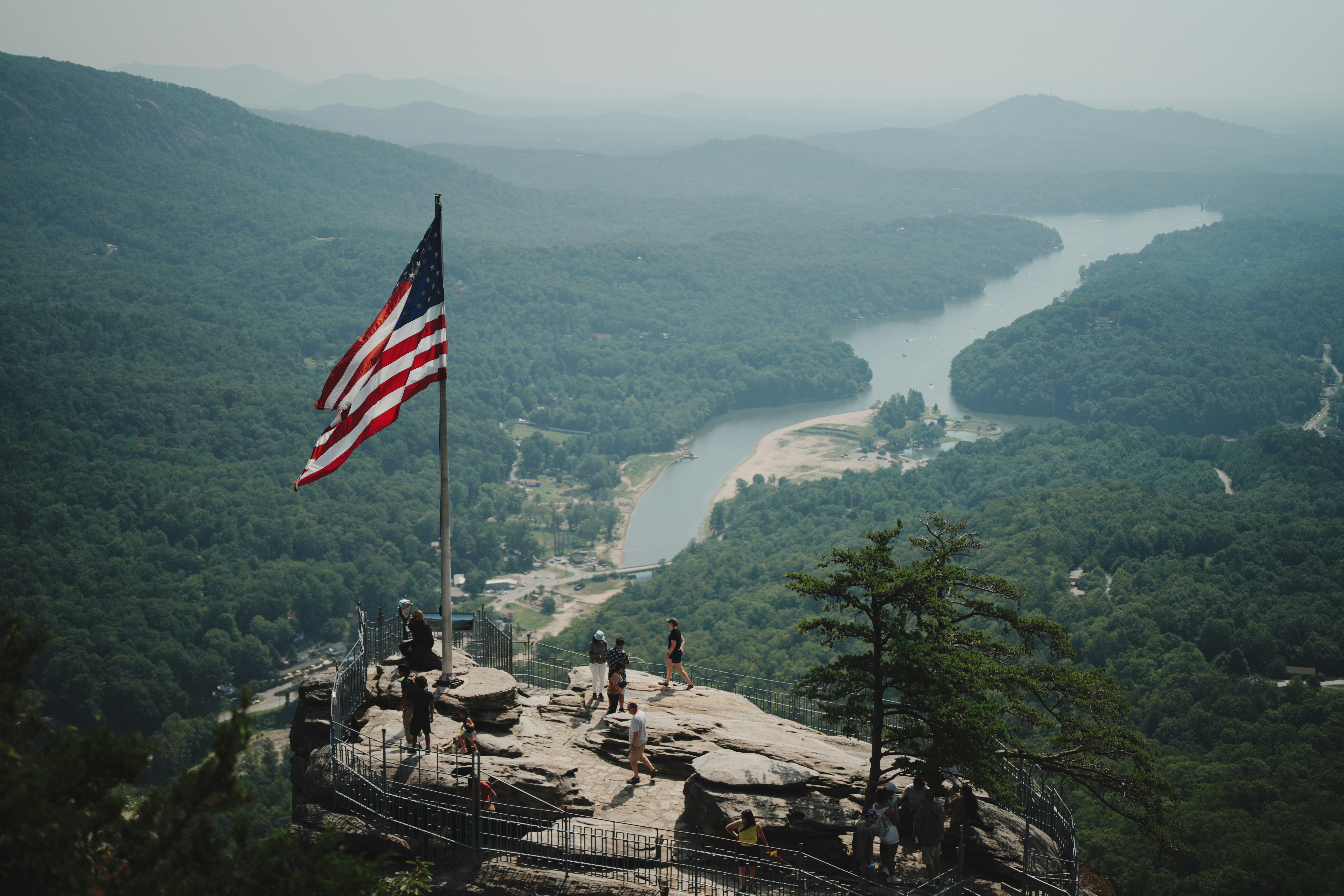 Flag at the Edge: Panoramic overlook atop a cliff