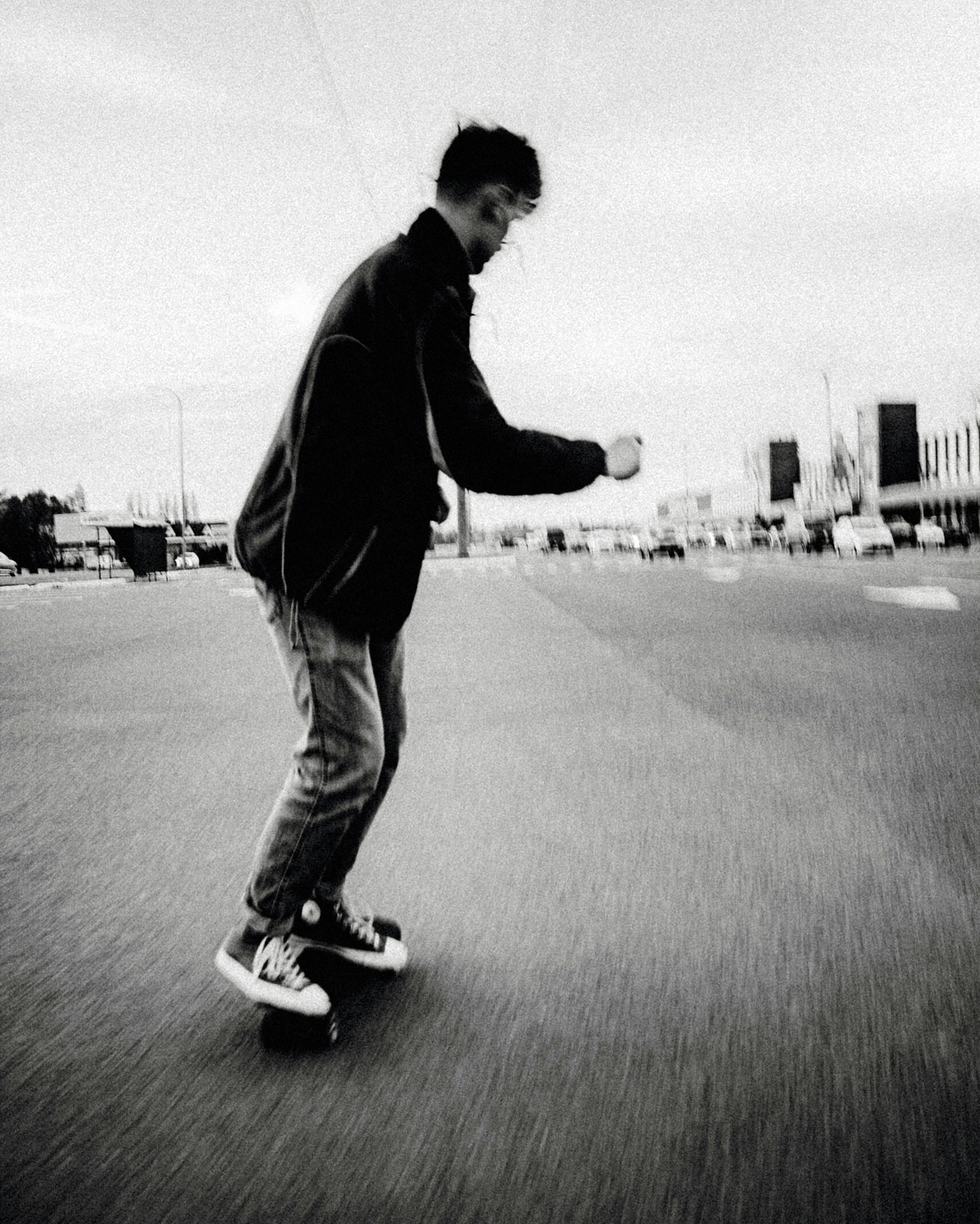 Skateboarder in motion: a grayscale urban drift