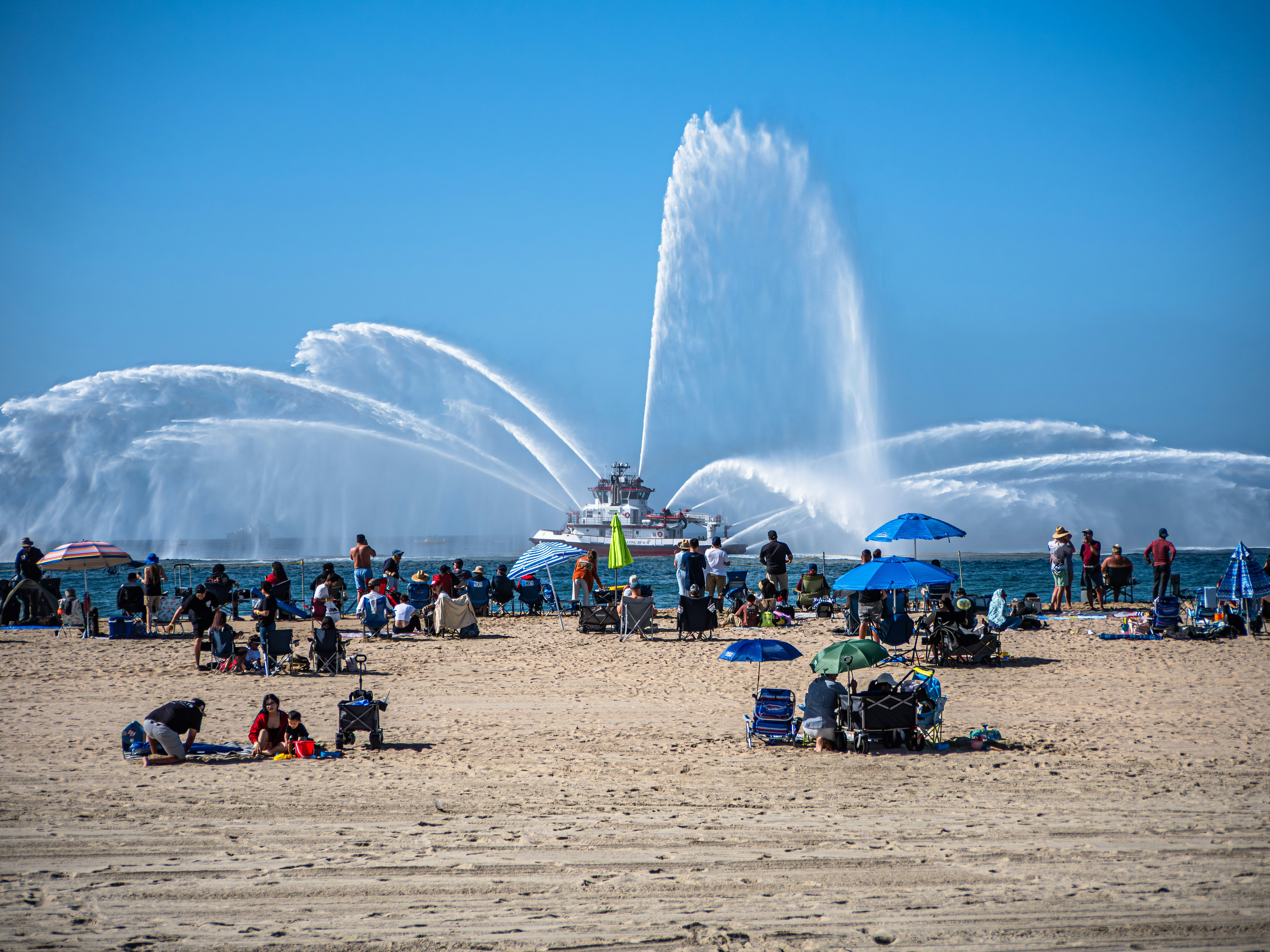 Jetting Cheers: Water Arches Crown a Sunny Beach Day