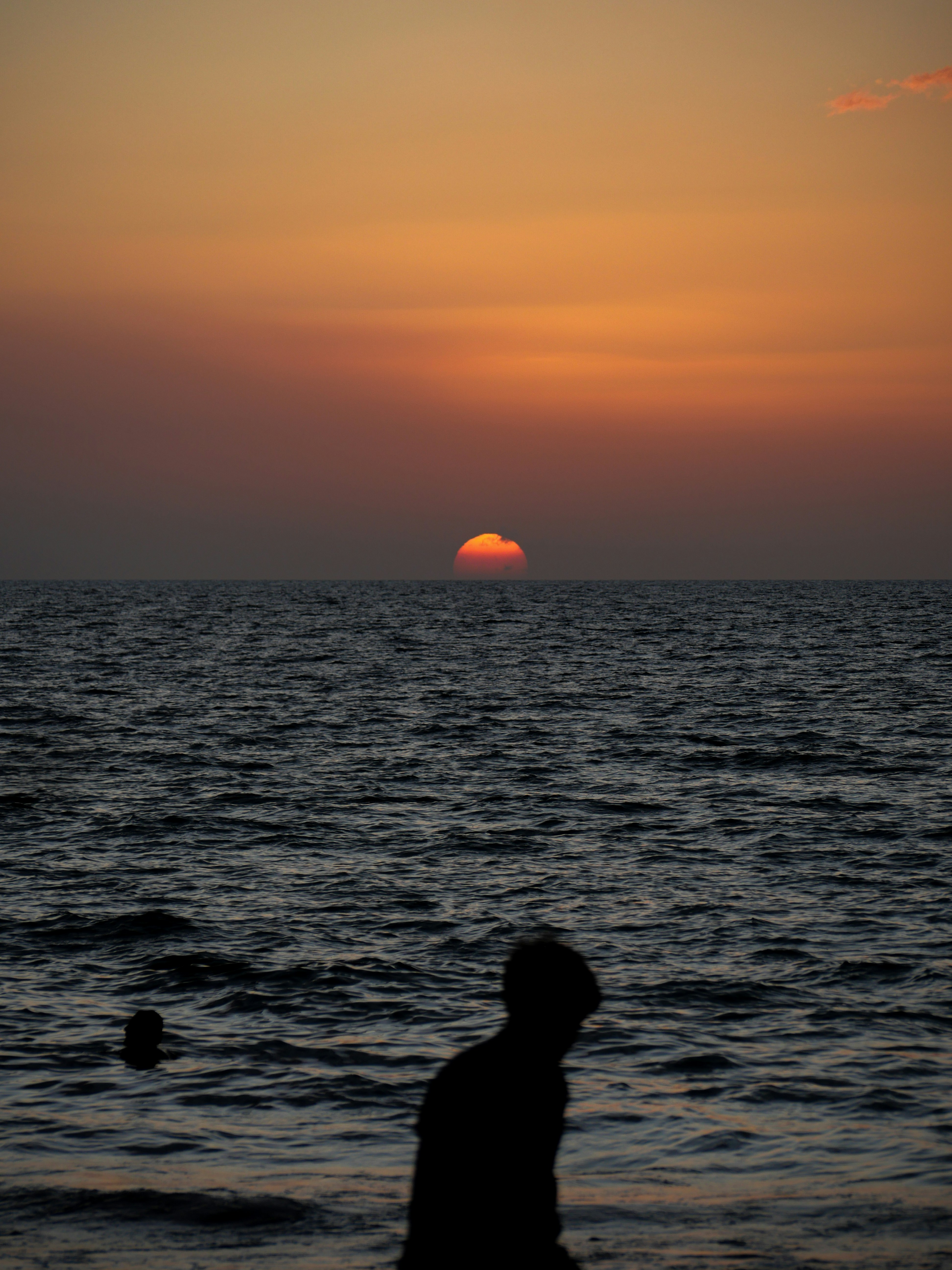 Sunset Silhouette Over Quiet Seas: The Moment the Sun Dips