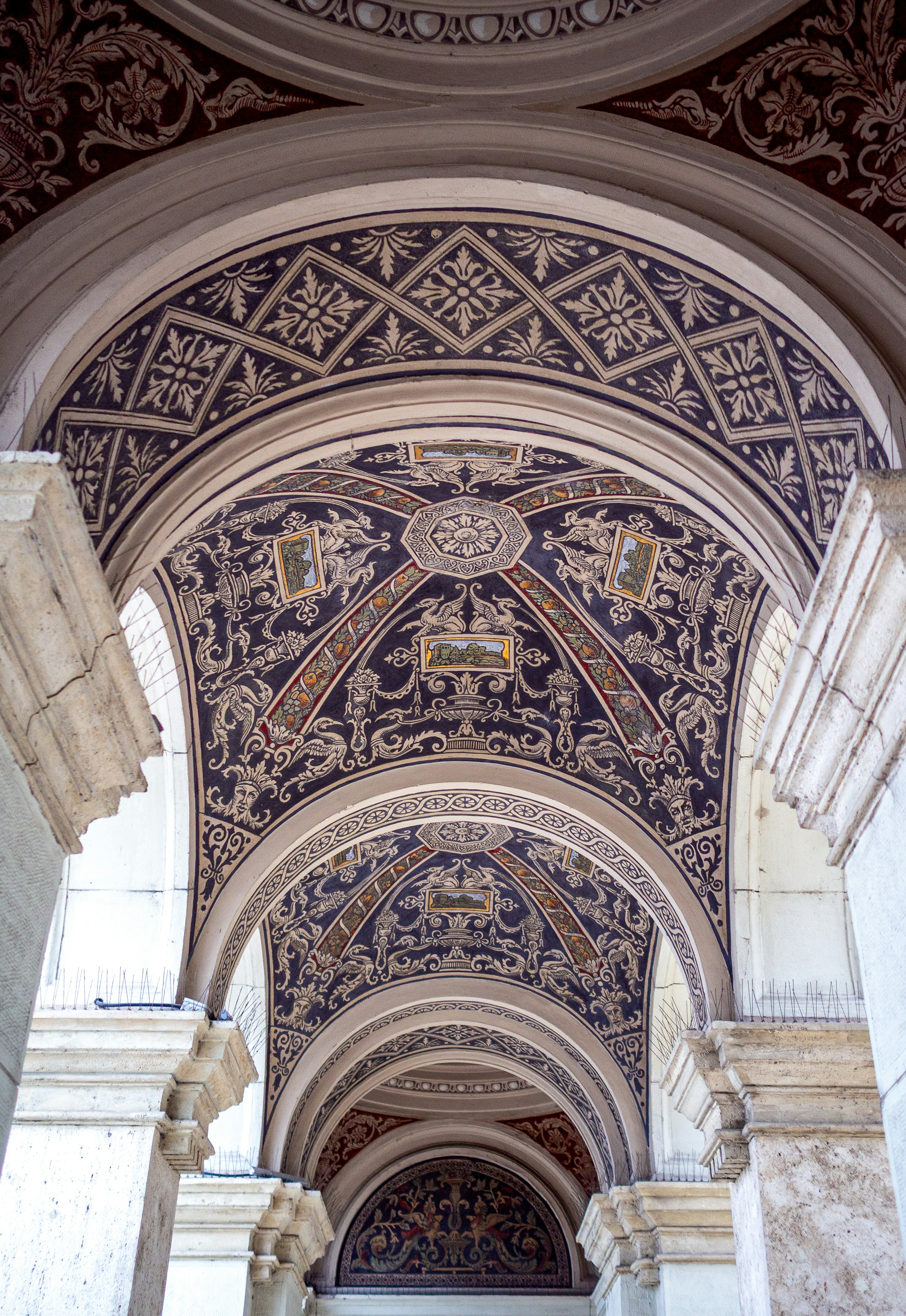 Arched Vaults: Ornate Carved Ceilings Guiding Stone Columns