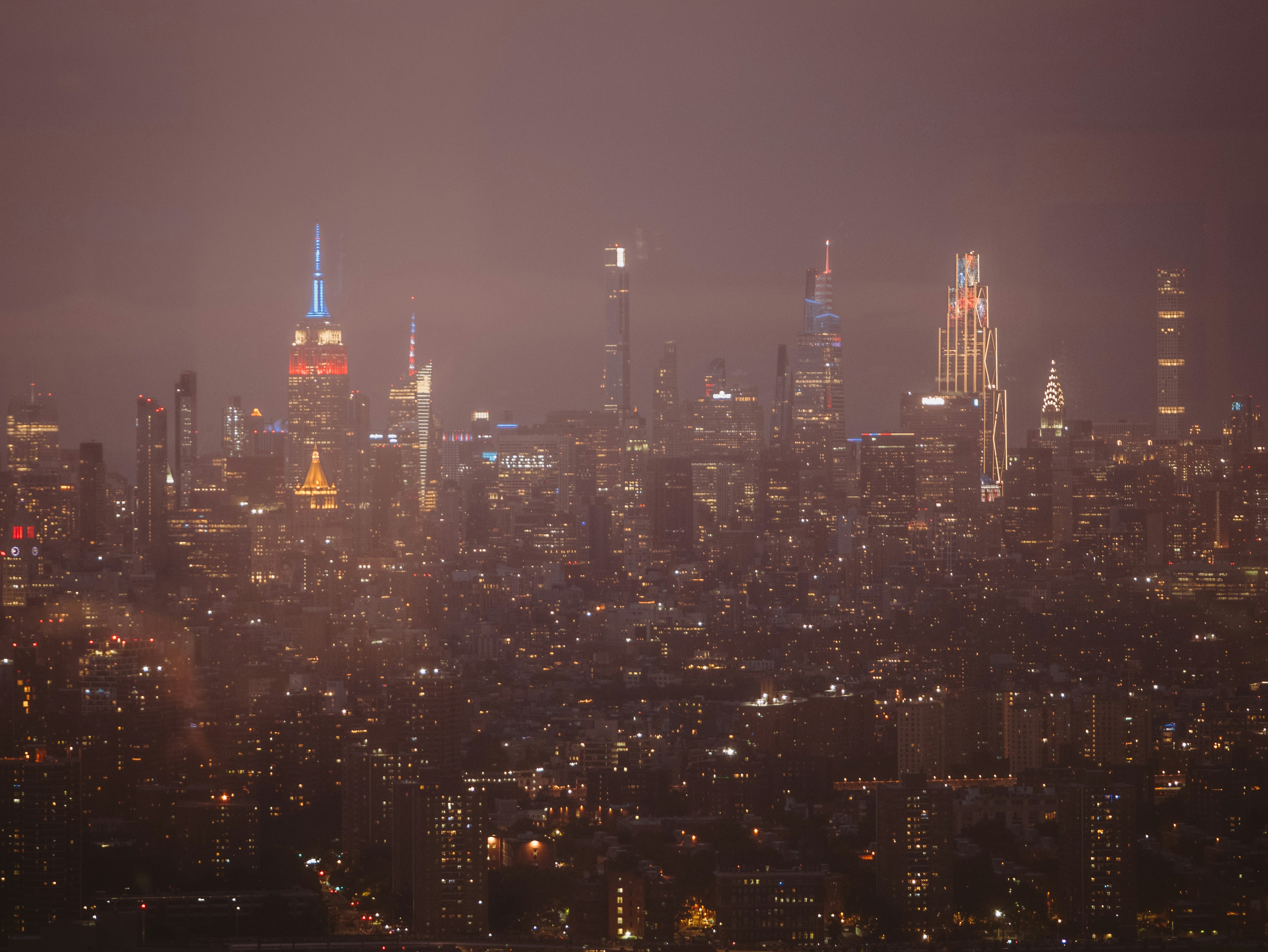 Nightfall Skyline: A Misty City Silhouette Beneath Neon Horizons