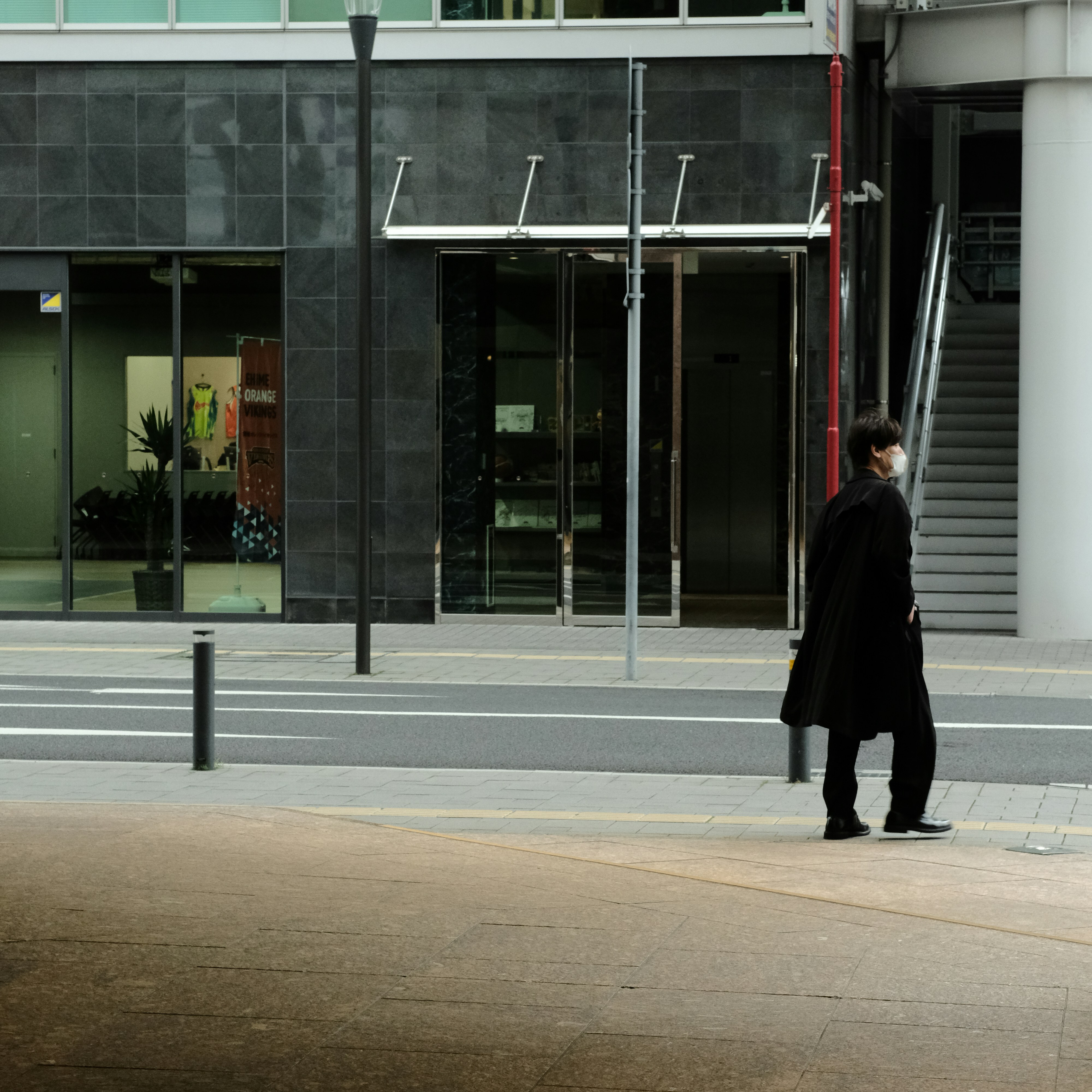 Passing silhouette in a city facade