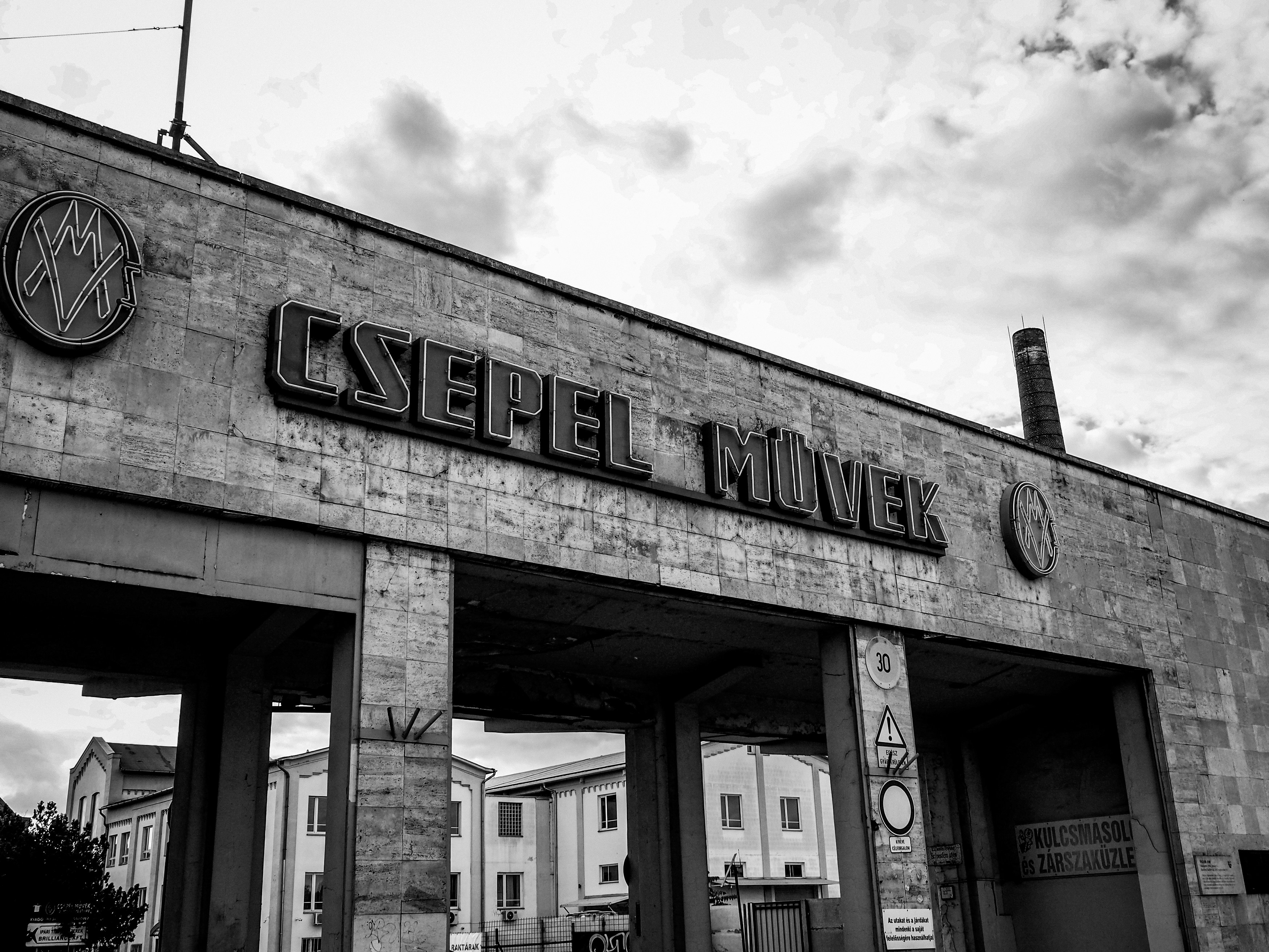 Crumbling Signage Over an Industrial Facade