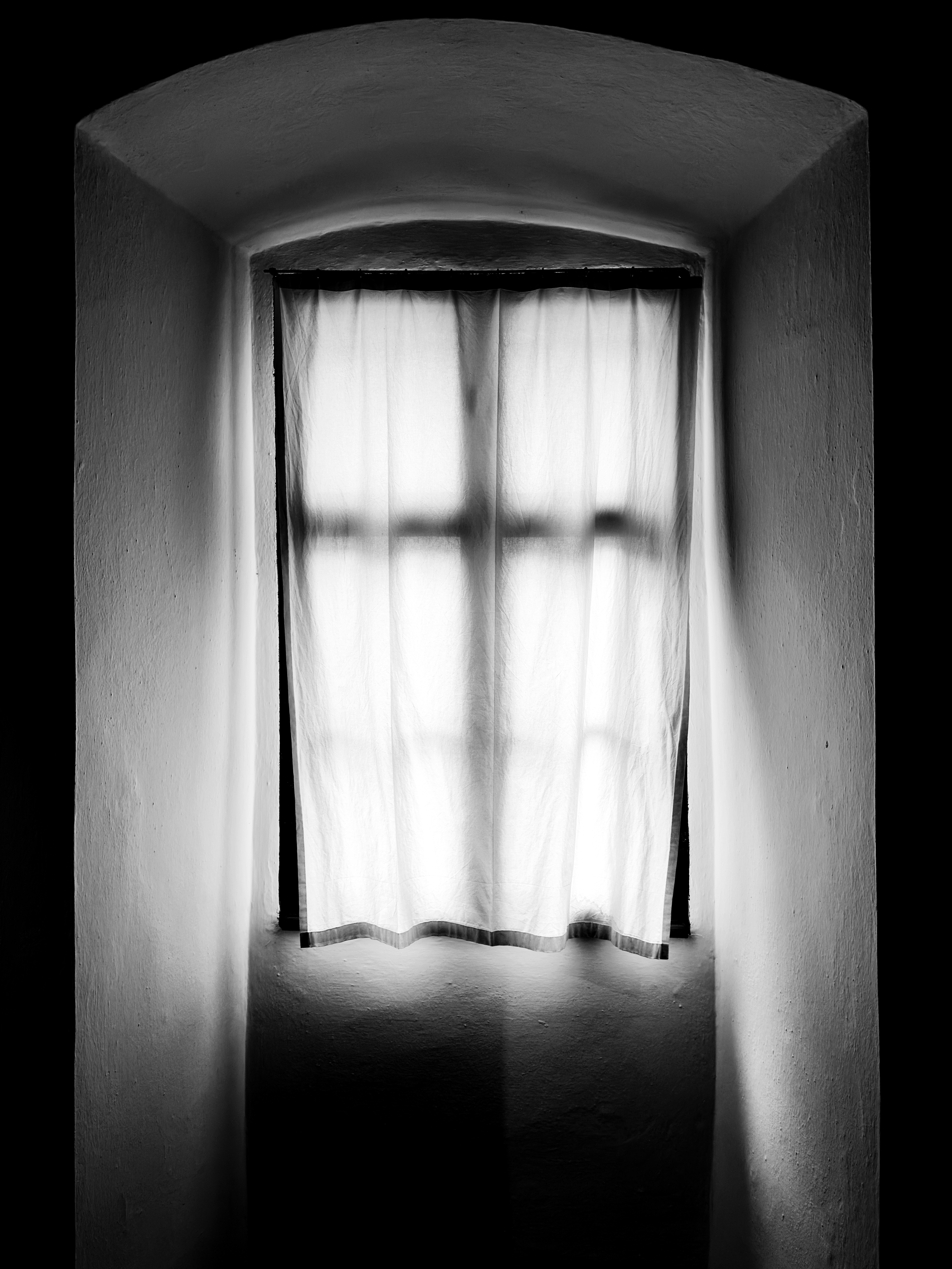 Window Veil: Light Framed by Shadowed Walls