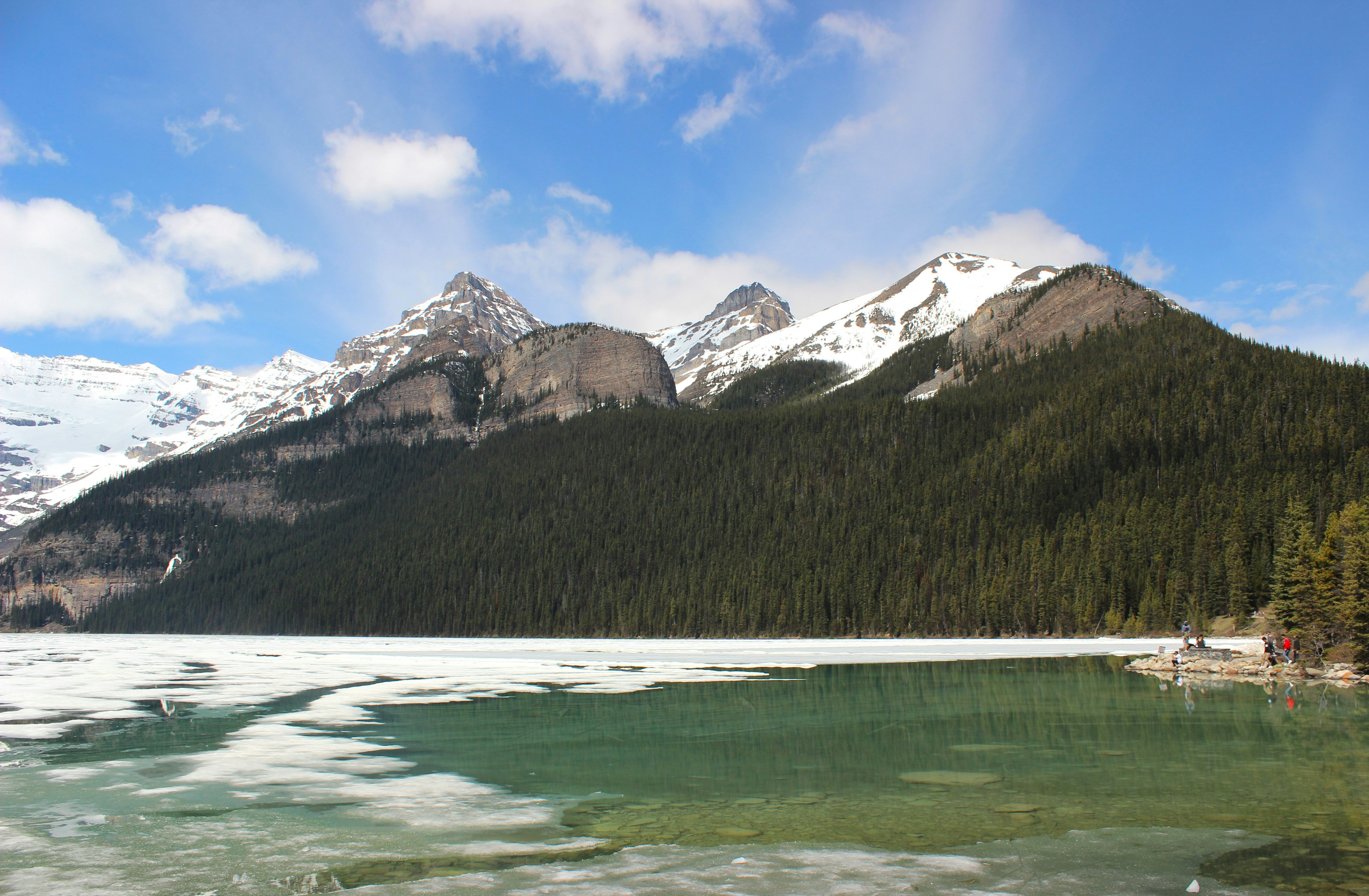 Glacial Lake Edge Under Snow-Capped Peaks