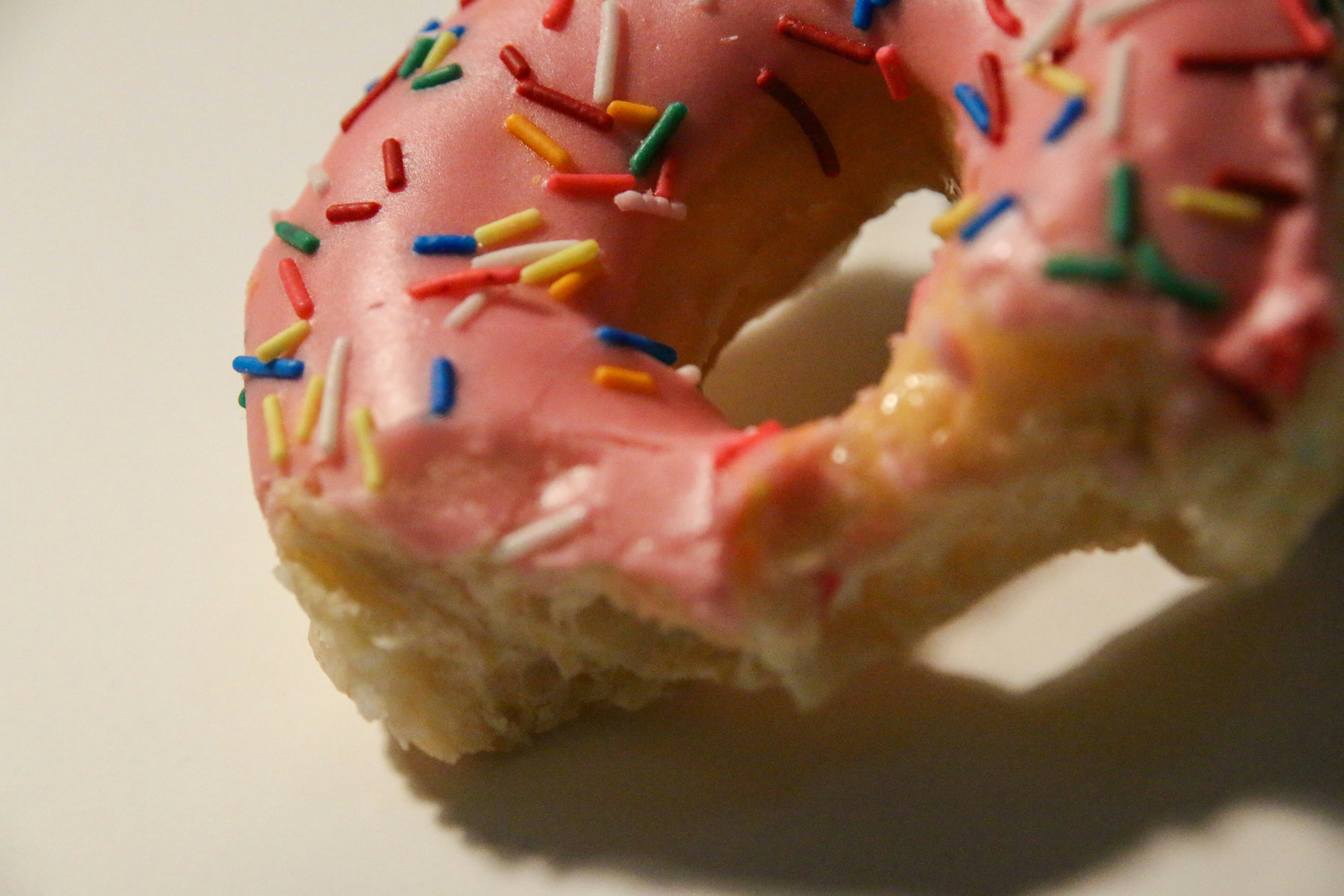 Sprinkled Sweet Focus: A Pink-Glazed Donut in Close-Up