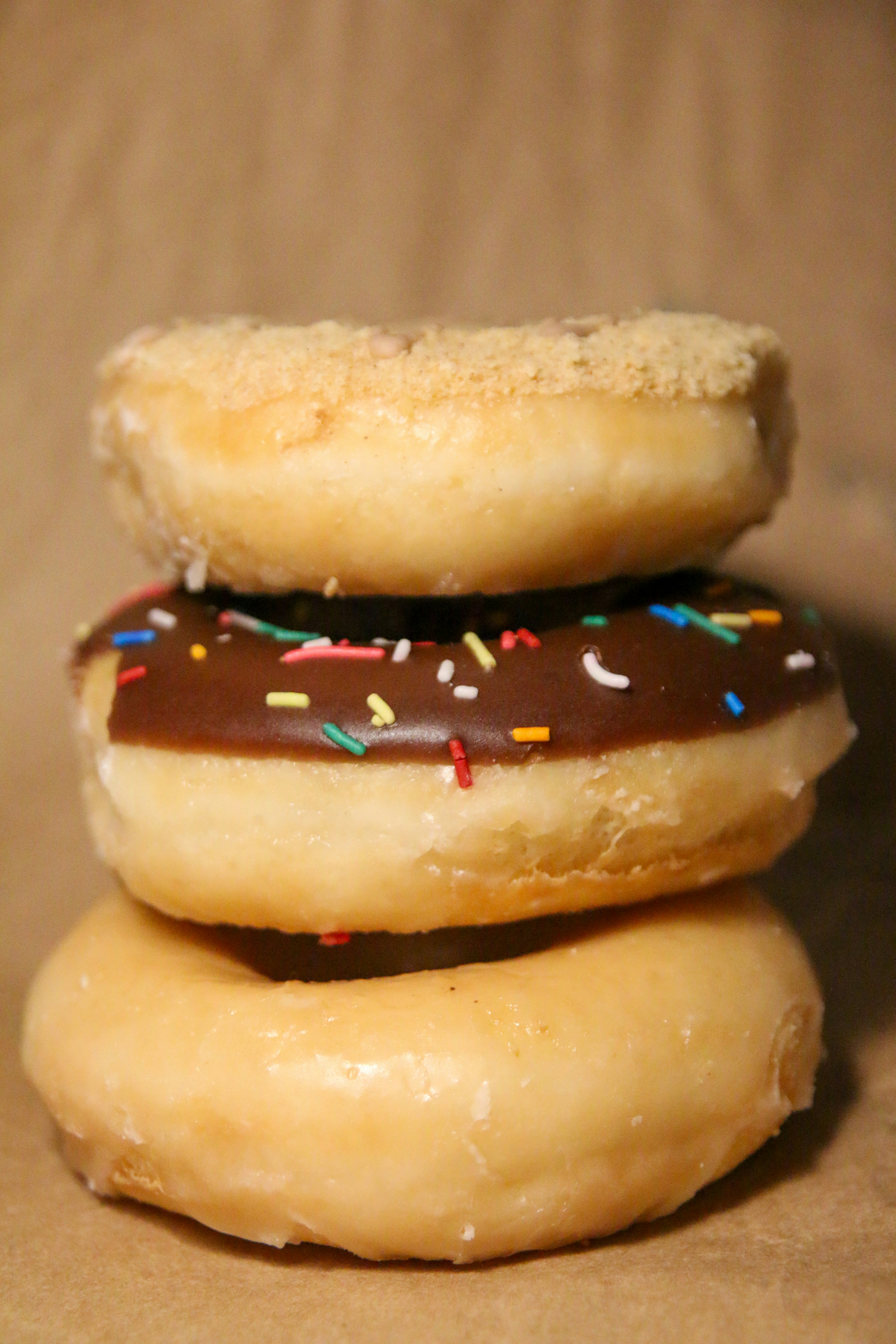 Stacked Indulgence: Glazed Donuts with Sprinkles in Quiet Focus