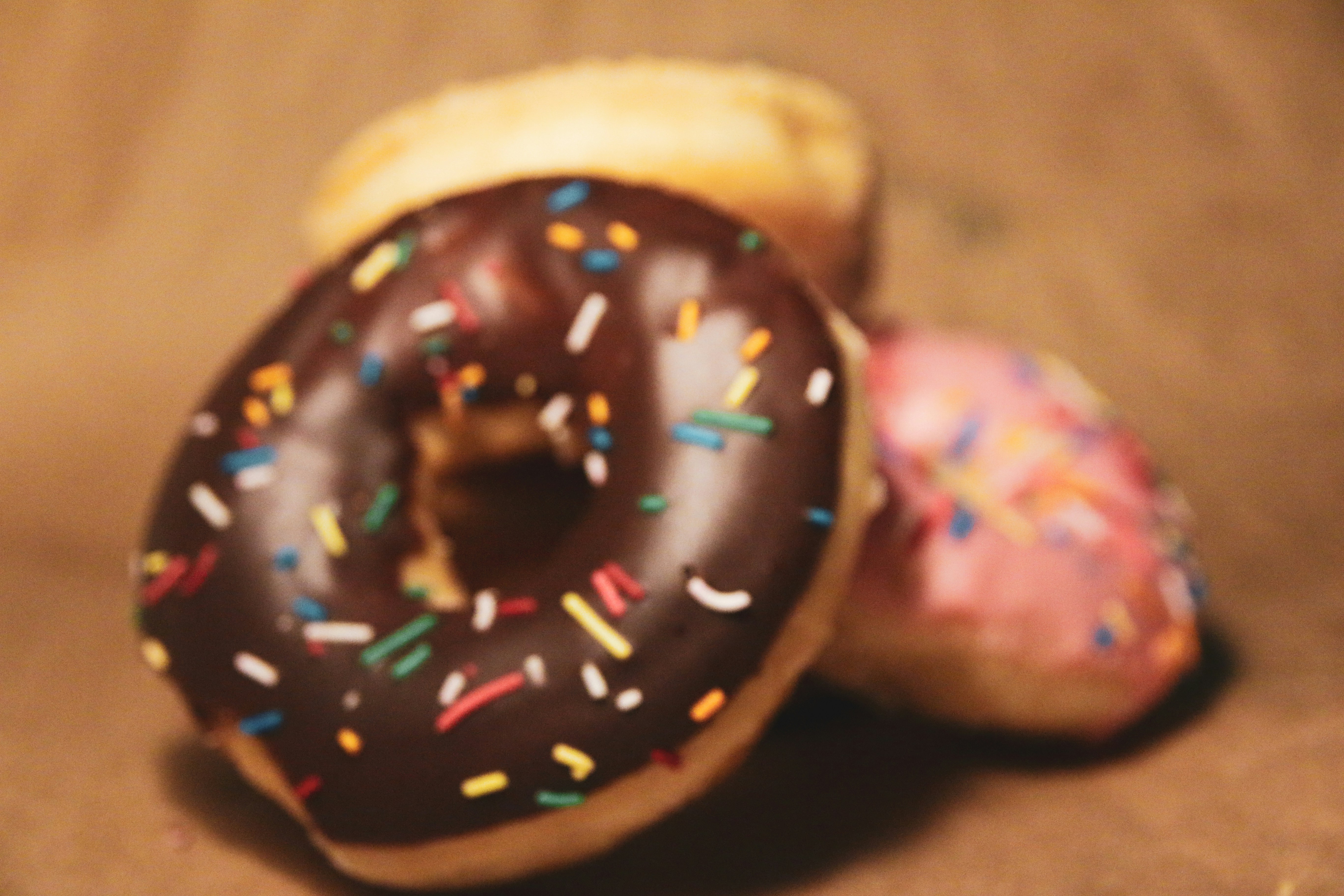 Chocolate-dusted Donut with Sprinkles in Focused Still Life