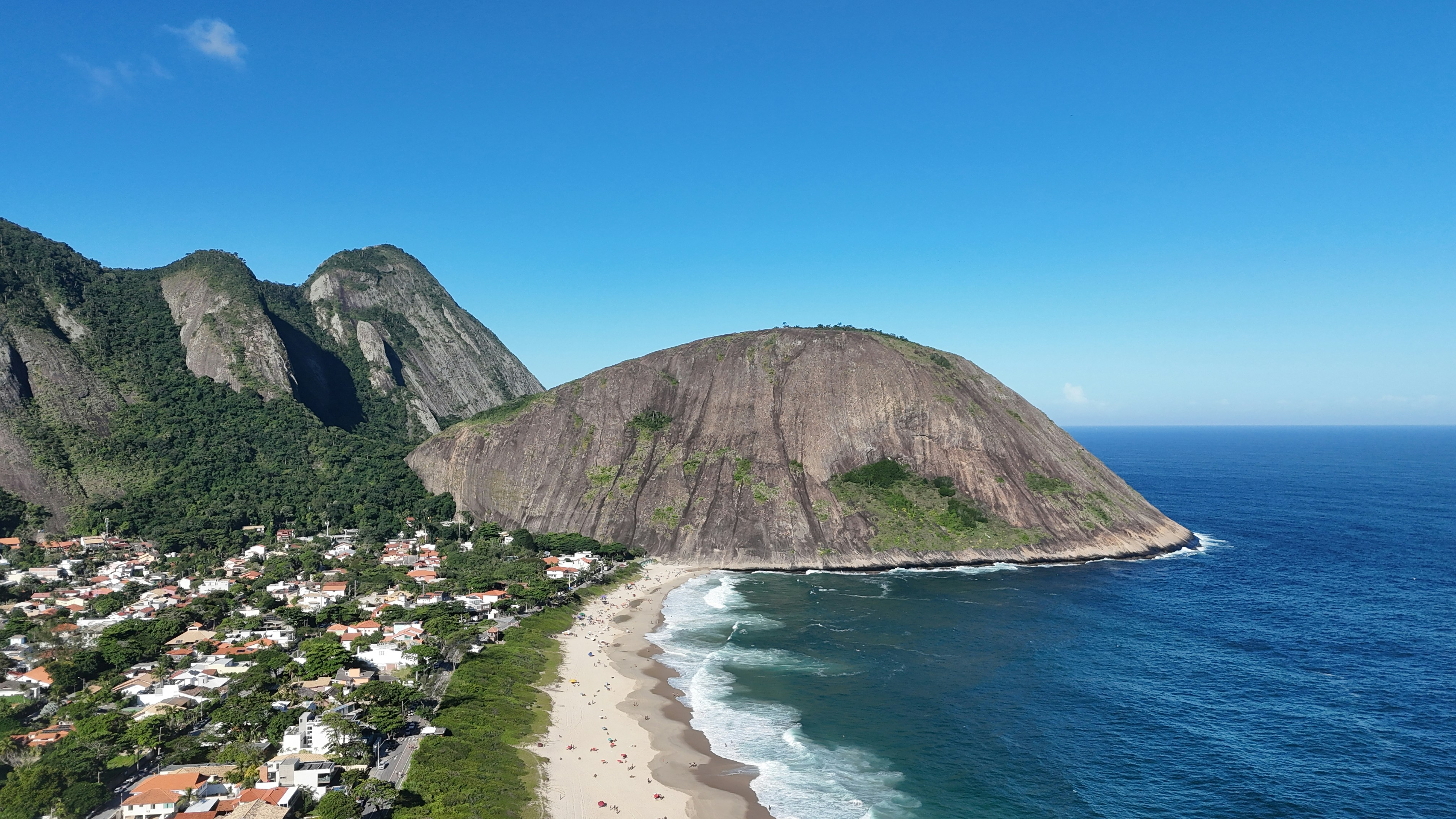 Coastal Bowl: Aerial View of a Quiet Ocean-Side Village Nestled Between Mountain and Sea