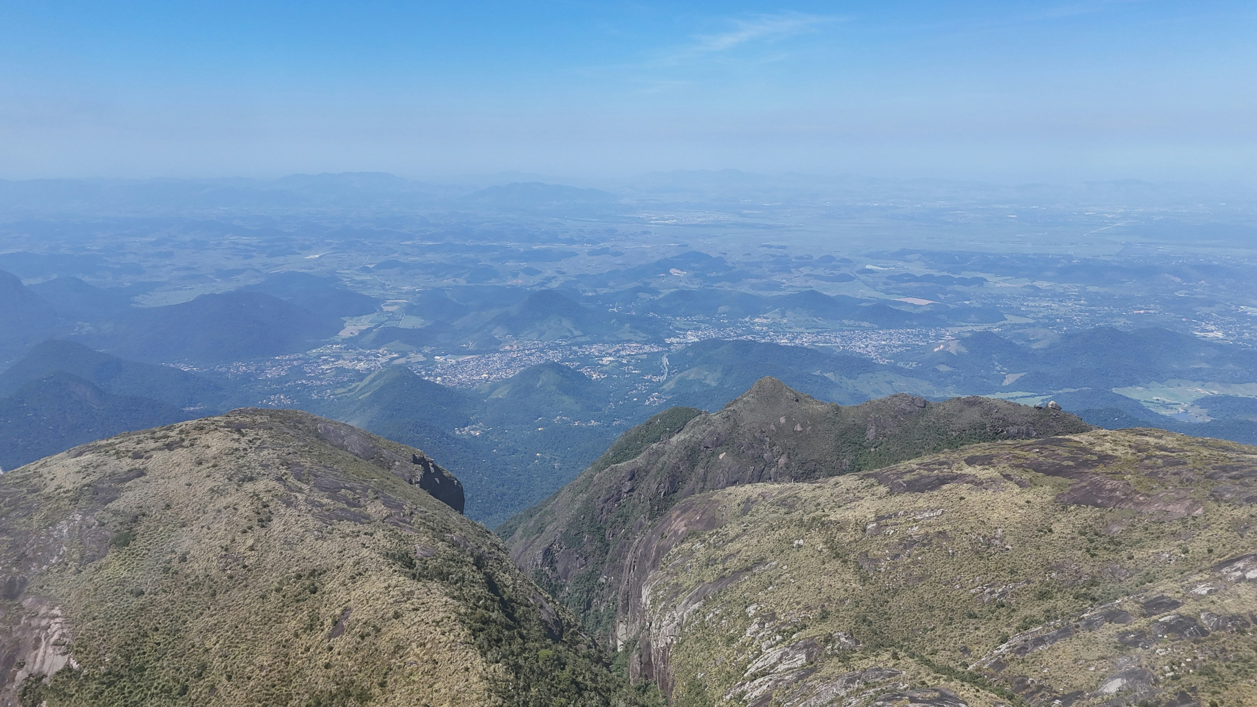 Summit Vista: River Valleys Unfold Beneath a Silhouette of Granite