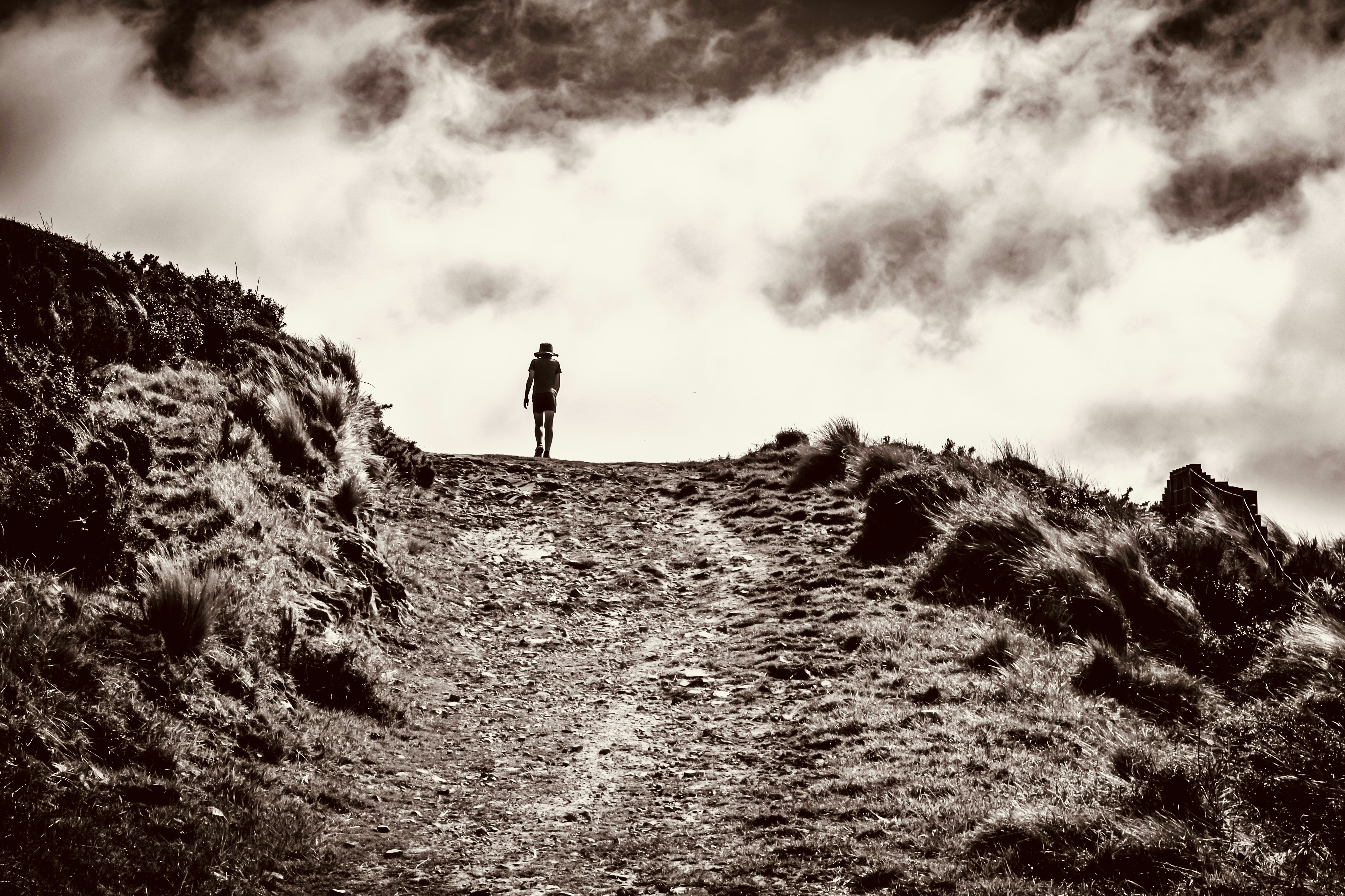 Alone on the Ridge: A Lone Hiker Against a Vast Sky
