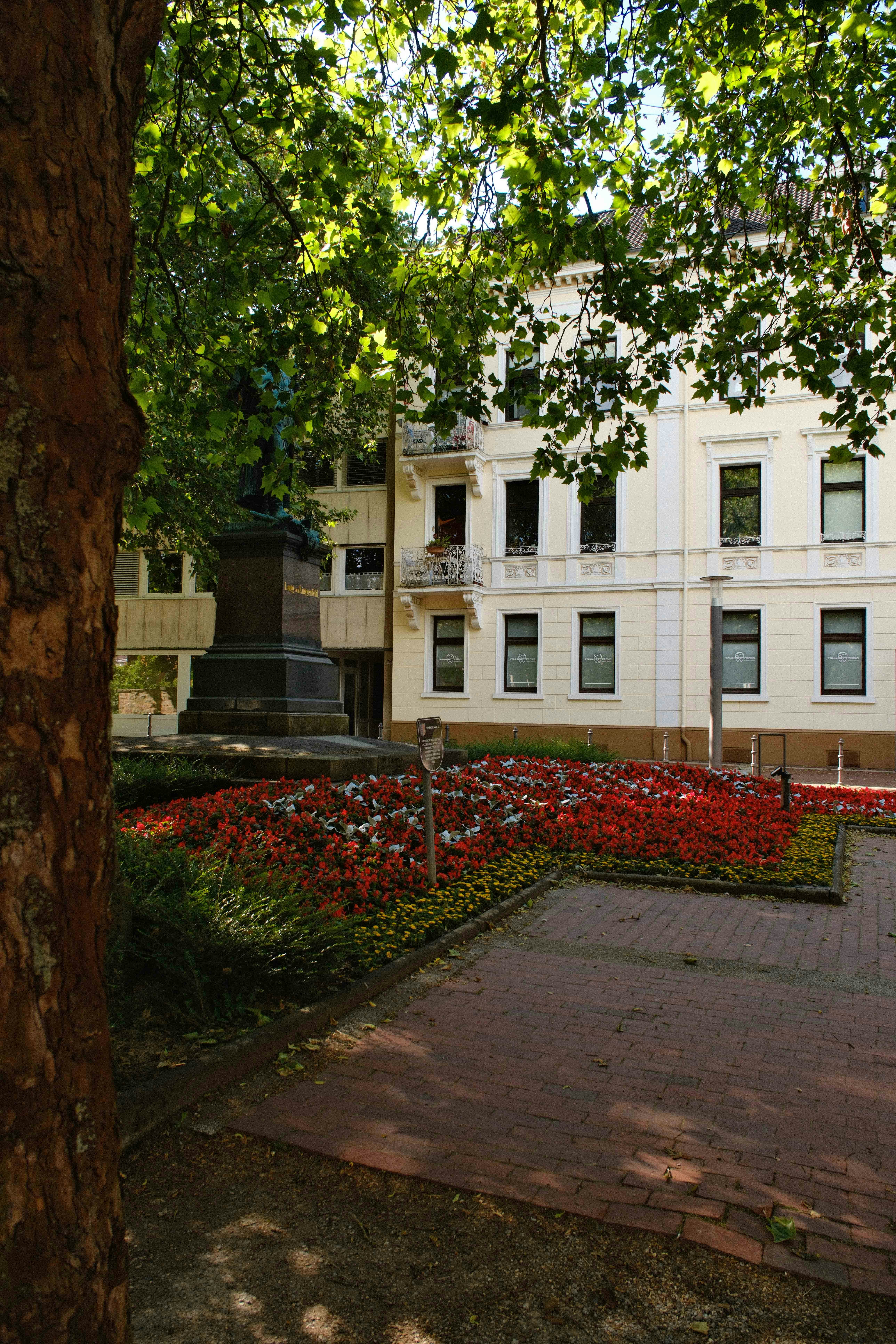 Brick Path through a City Garden Toward a Bright Facade