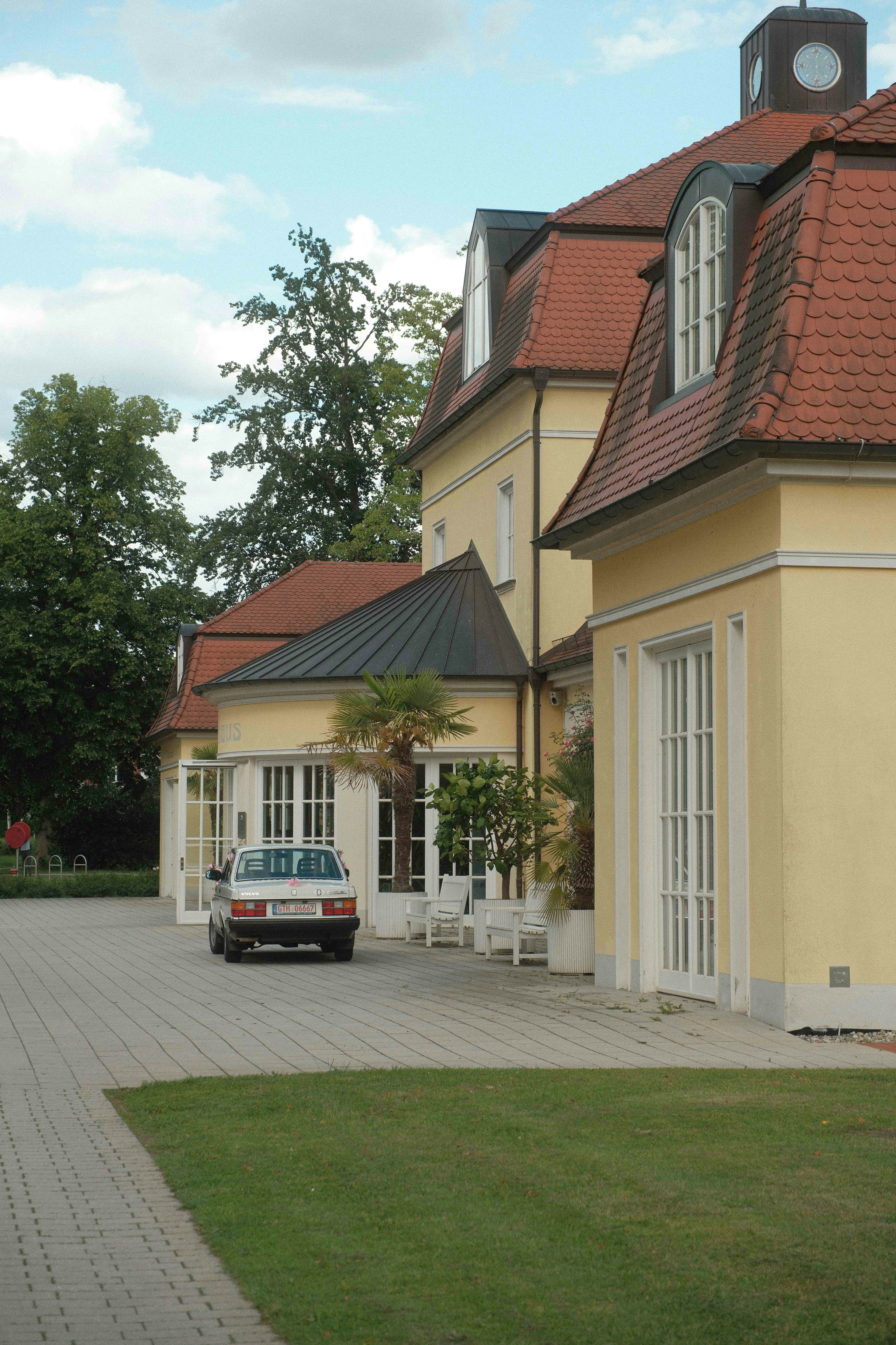 Yellow villa clutching a red-tiled roof under a blue sky