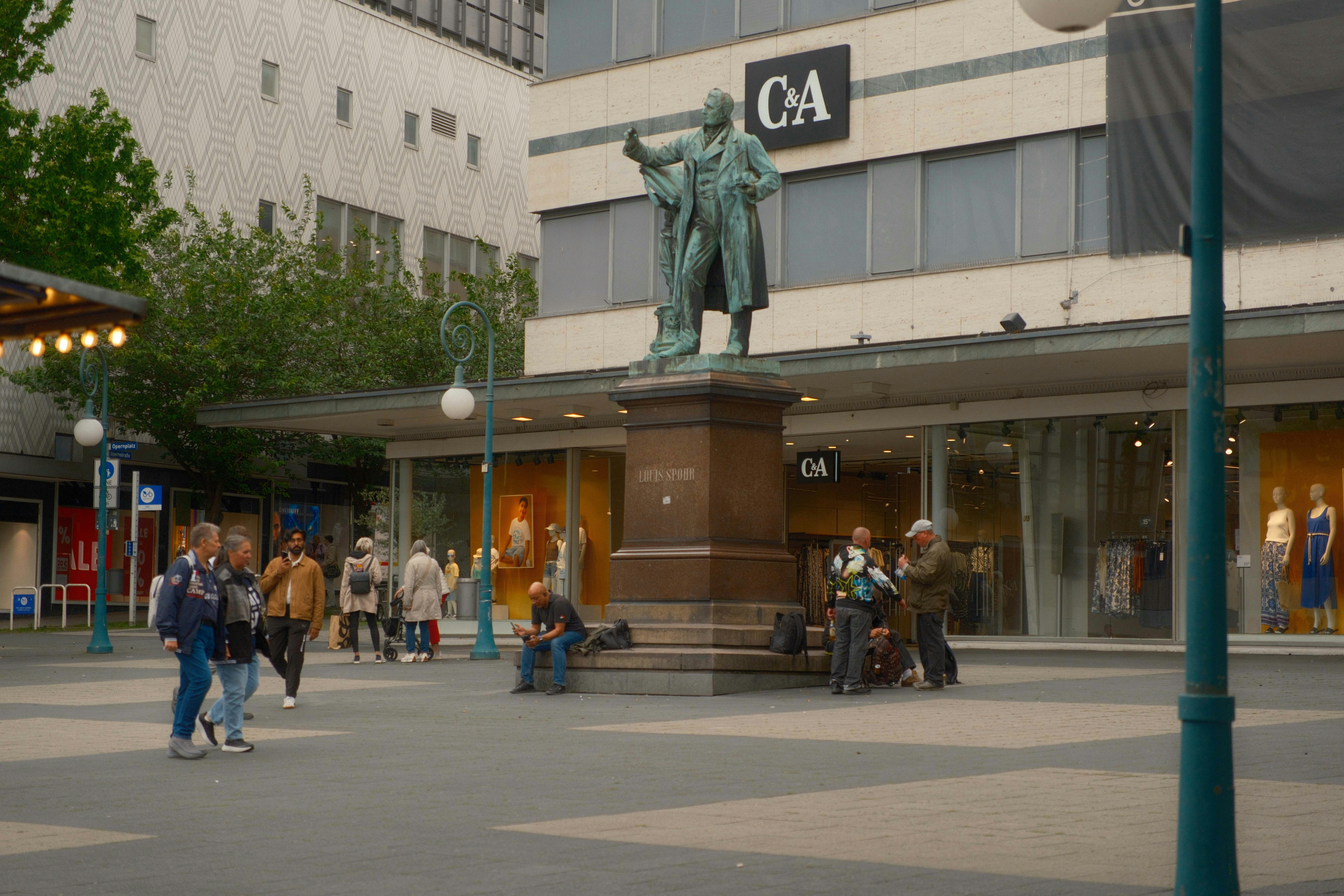 Statue in the Square: A Quiet Moment by the C&A Facade