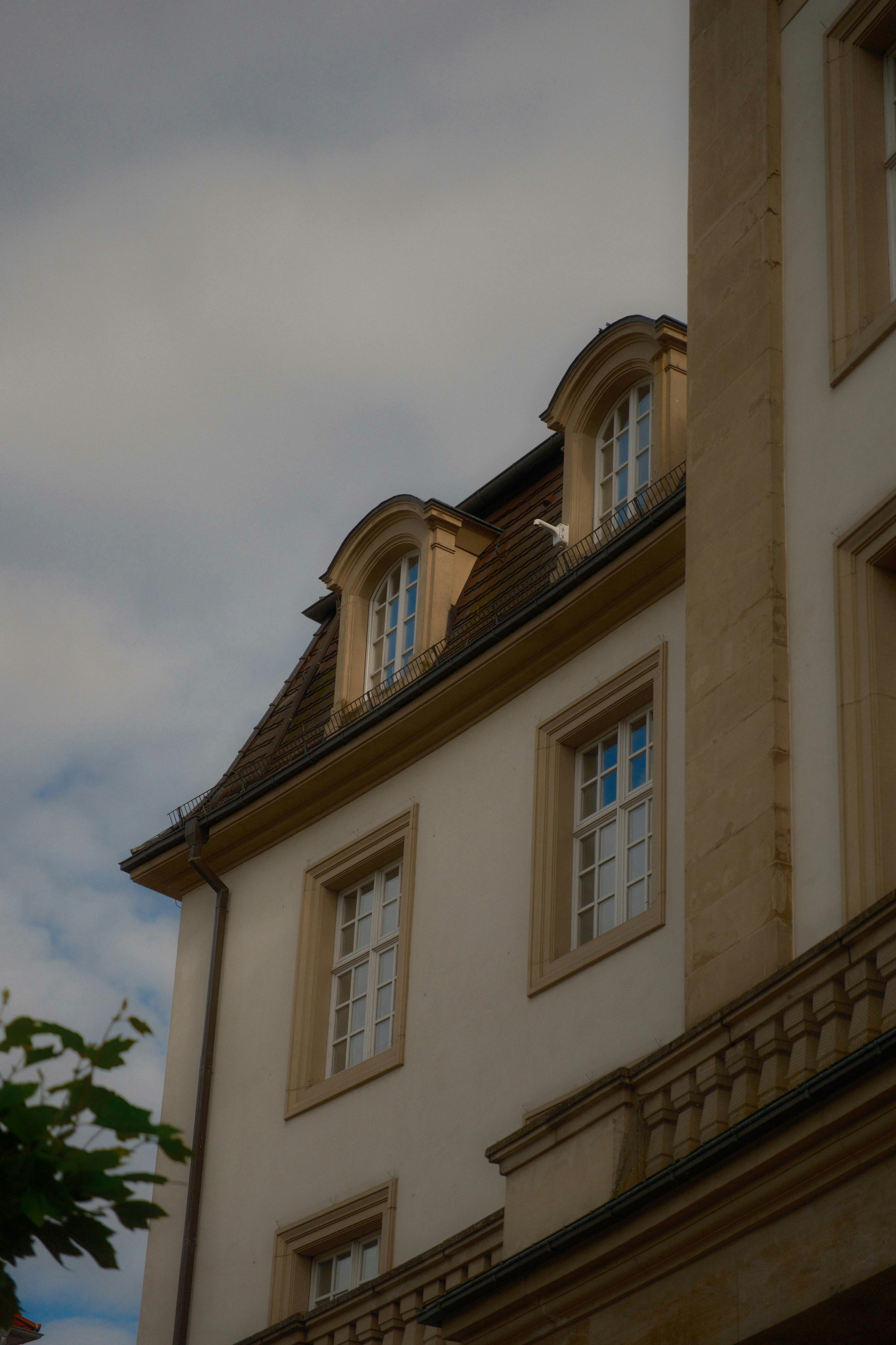 Ornate Dormers Against a Pale Facade