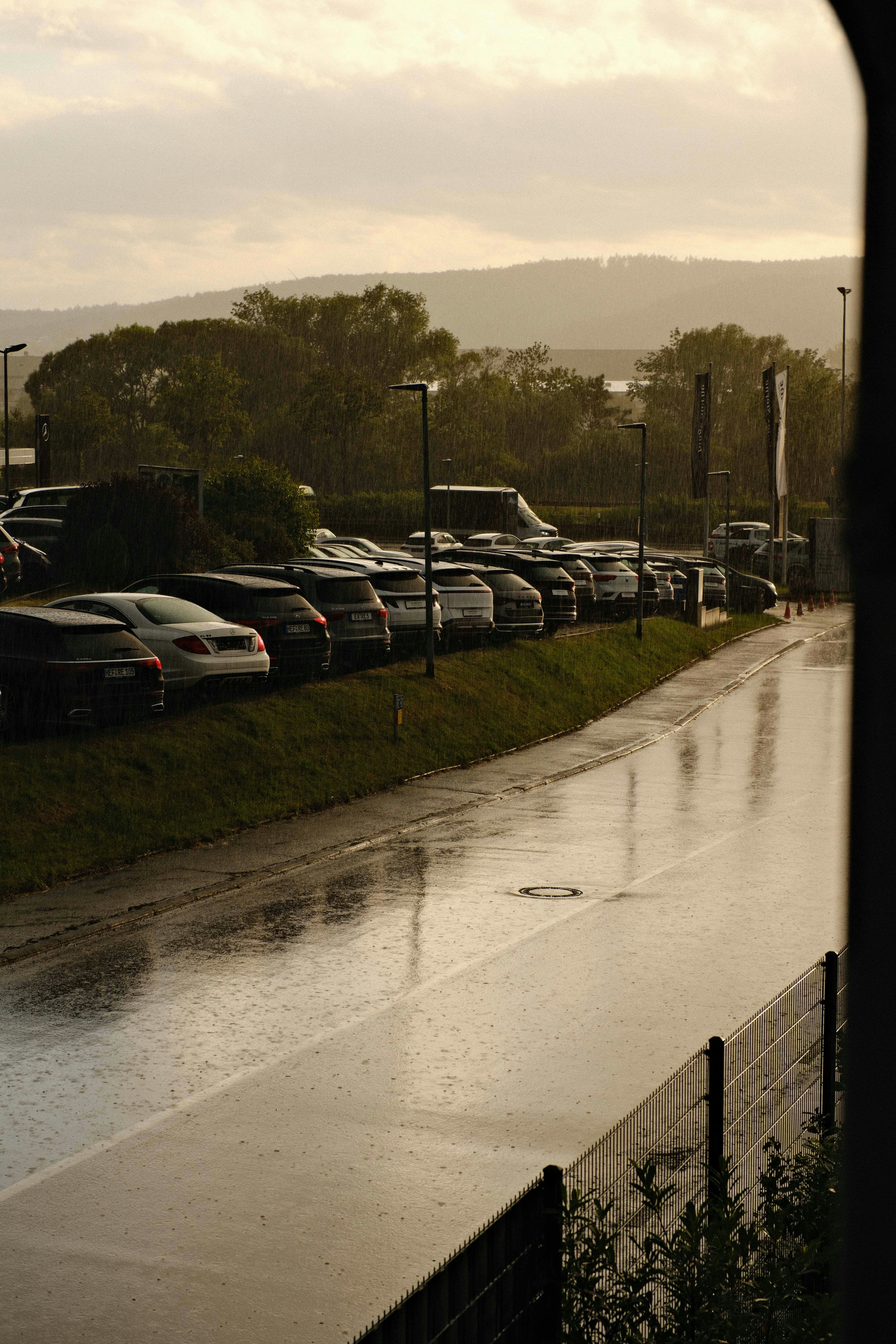 Rain-Slicked Parking Lot Panorama from a Bus Window