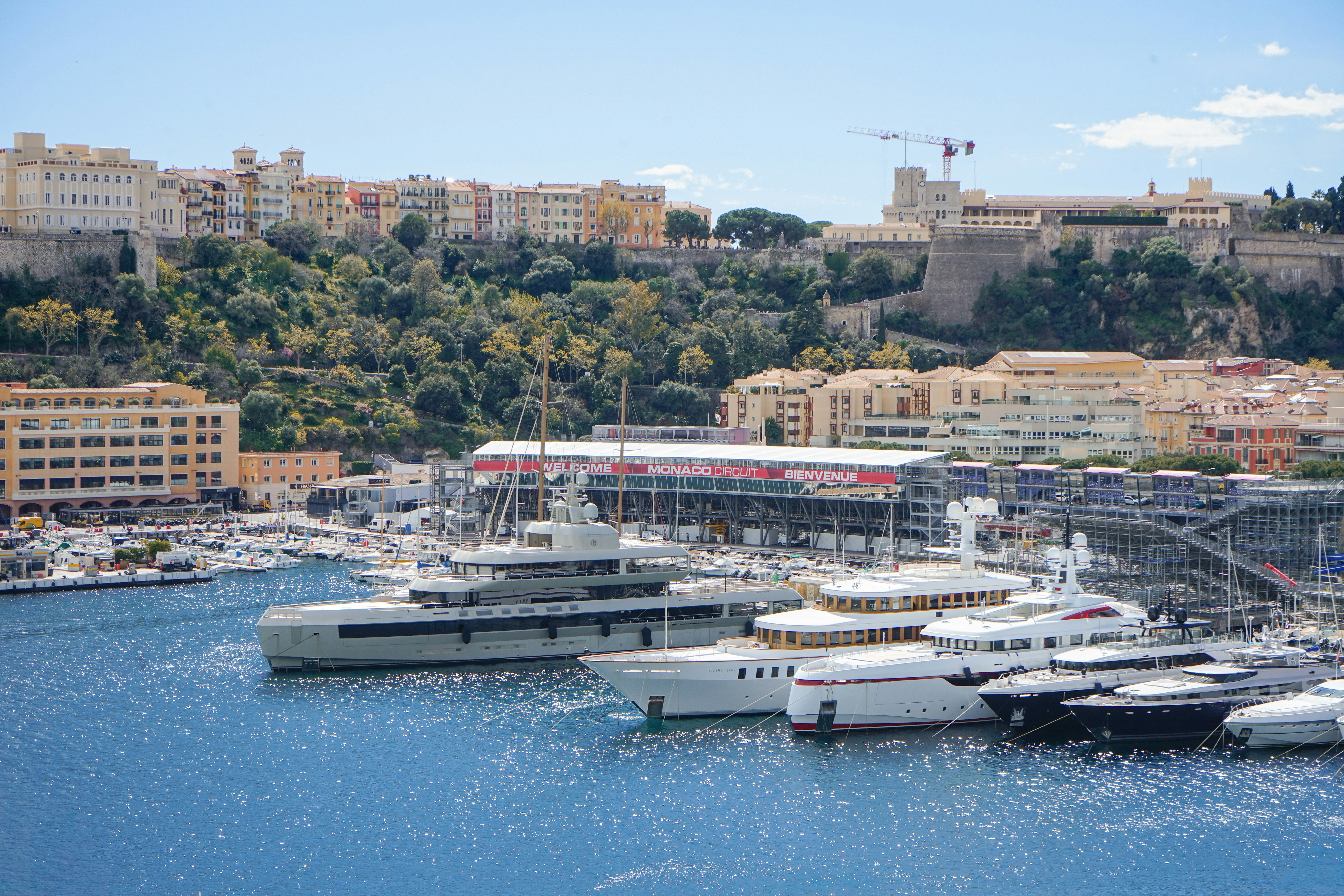 Marina panorama: docked yachts meet hillside cityscape