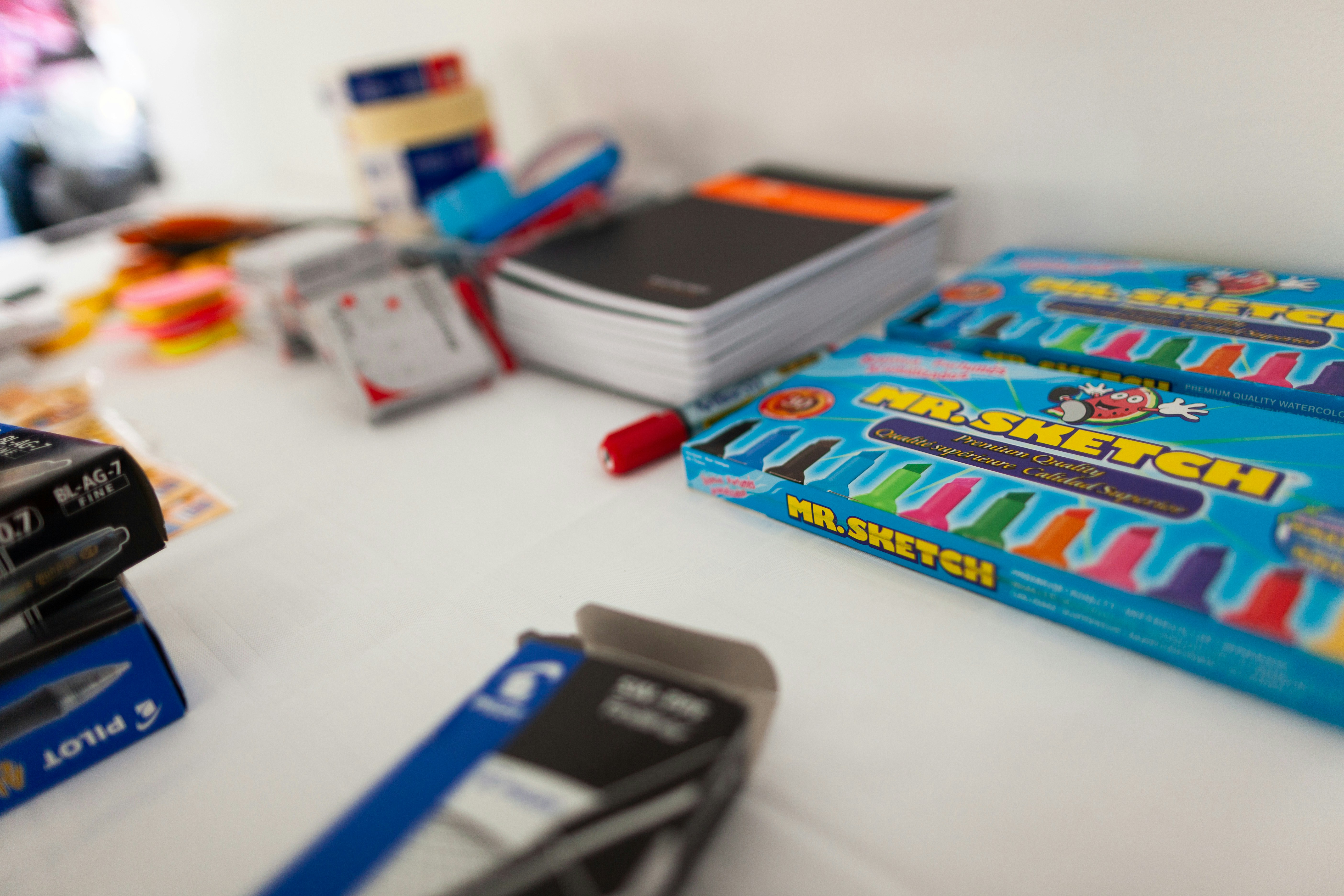 Colorful Desk Essentials: Crayons and Sketch Pads in a Blur of Creative Clutter