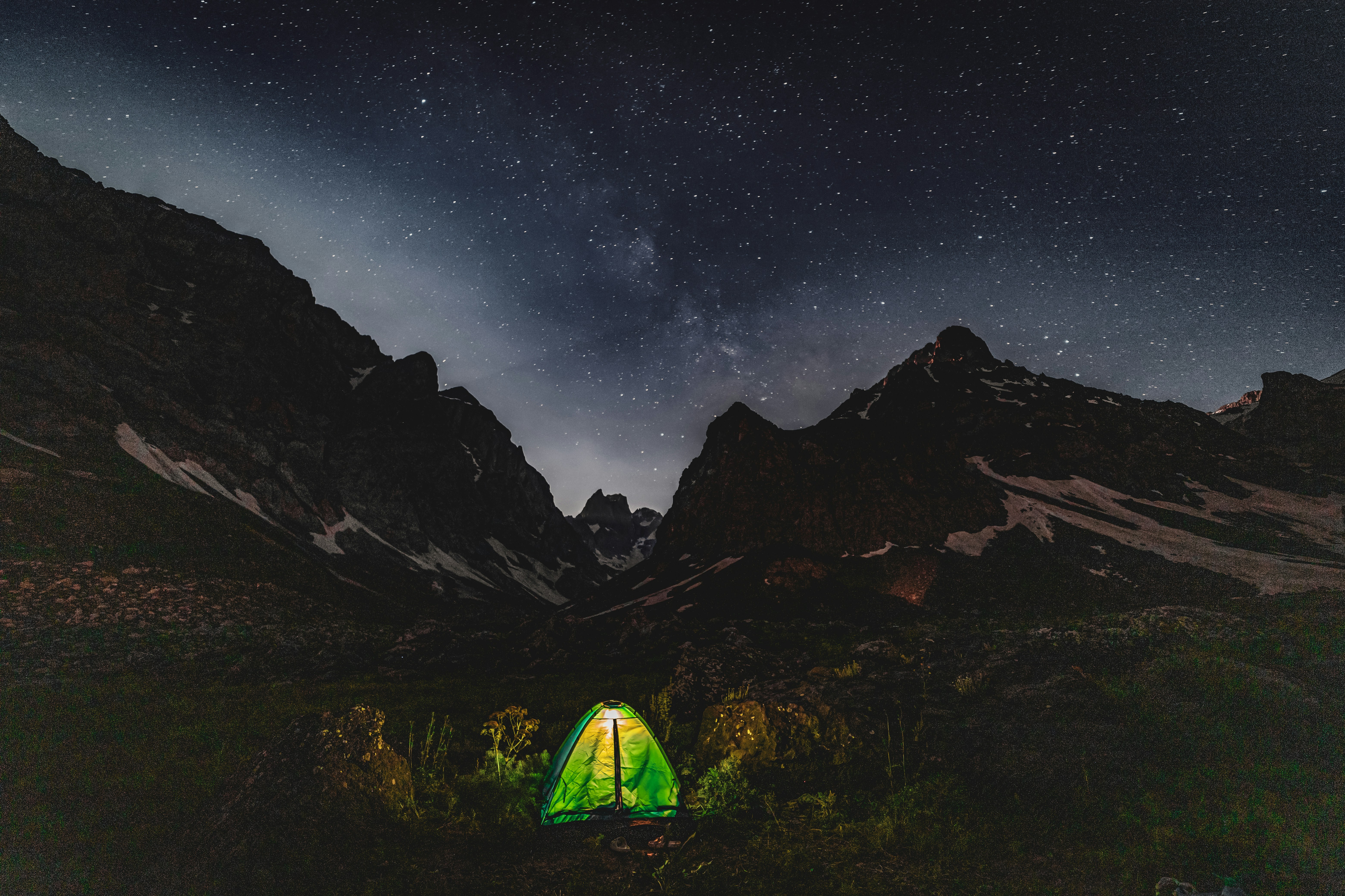 Low-Light Oasis: A Green Tent Anchored by the Milky Way