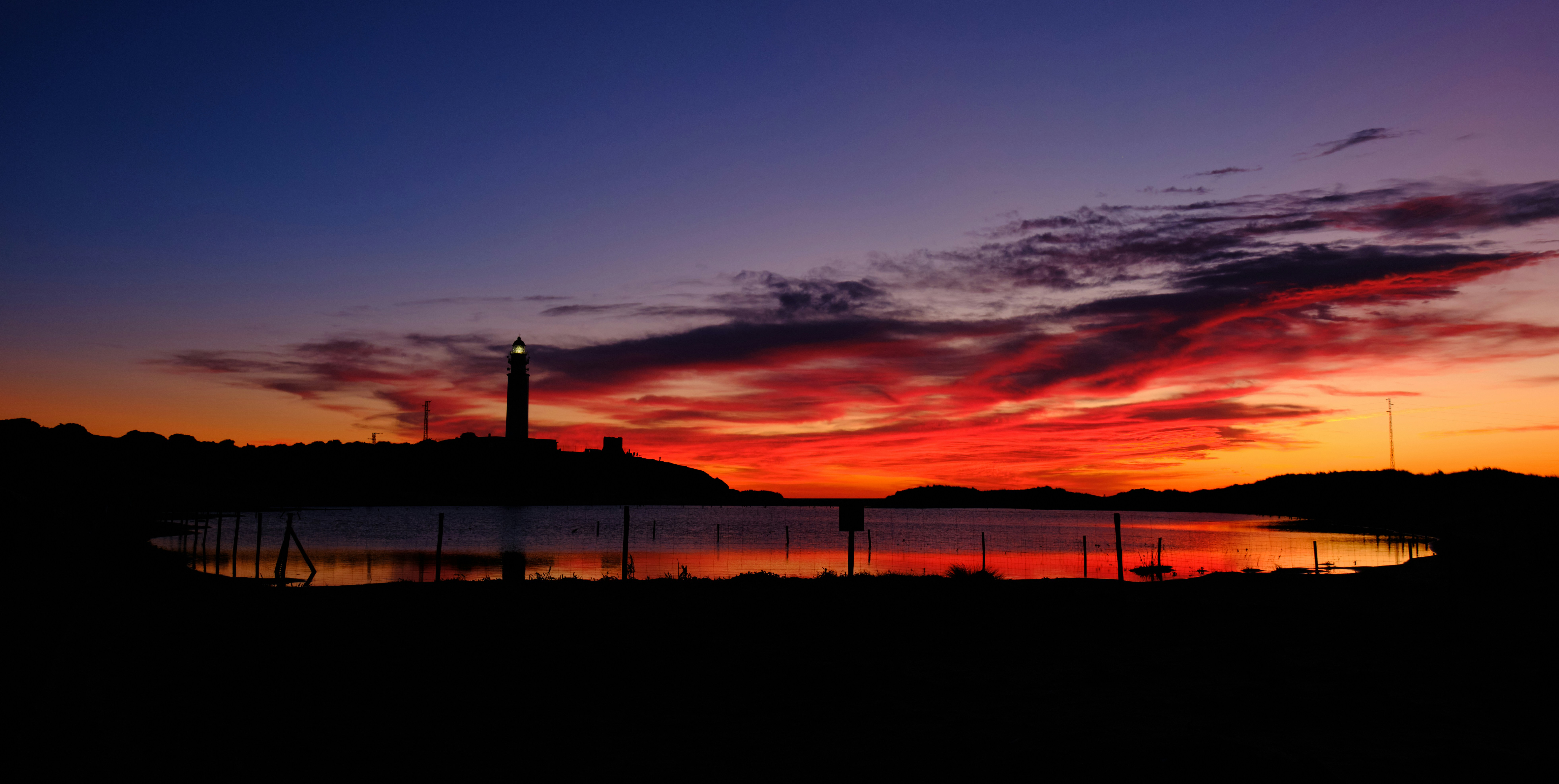 Twilight Lighthouse Over Silenced Waves