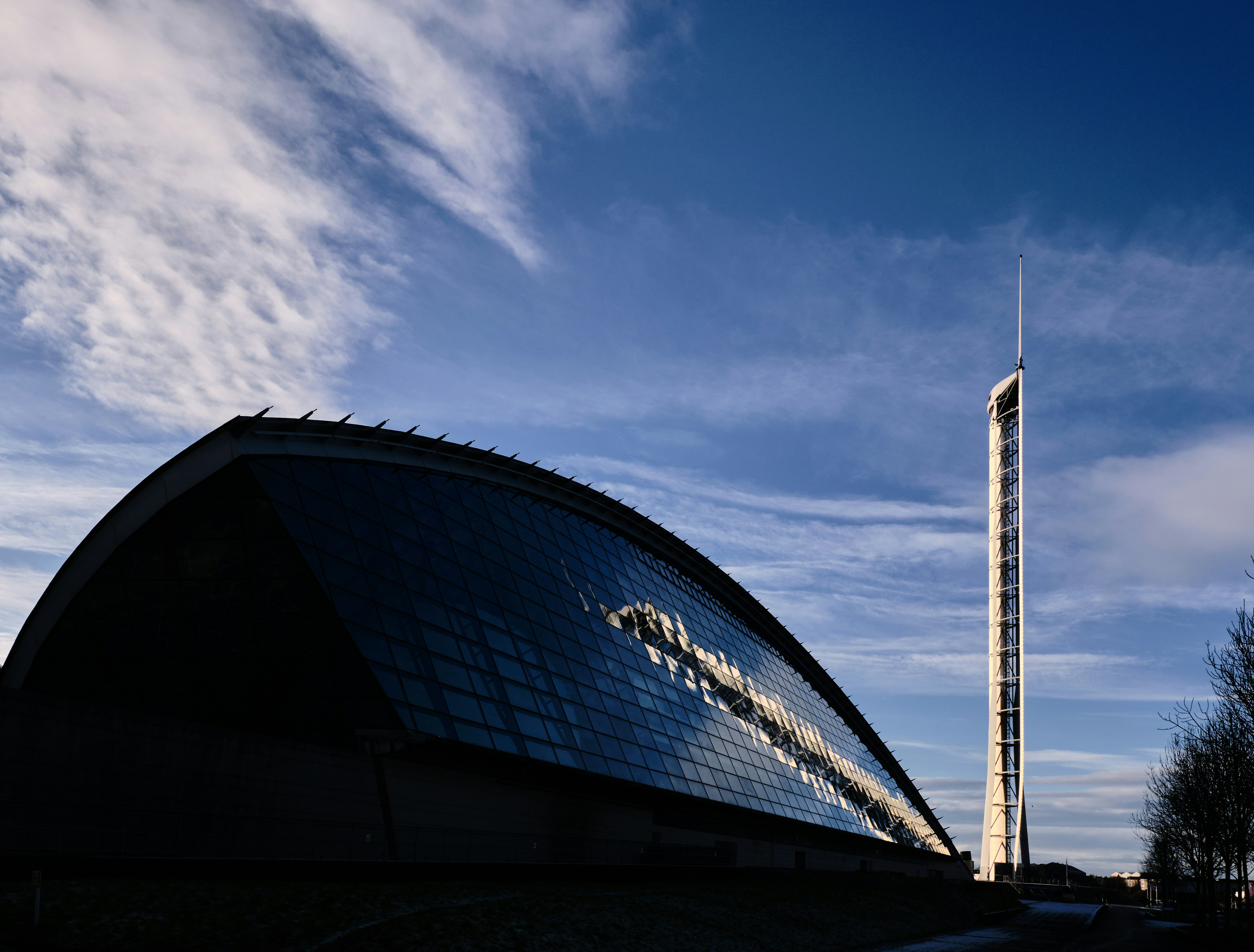Arc of Glass and Tower: A Low-Angle Crane toward the Sky