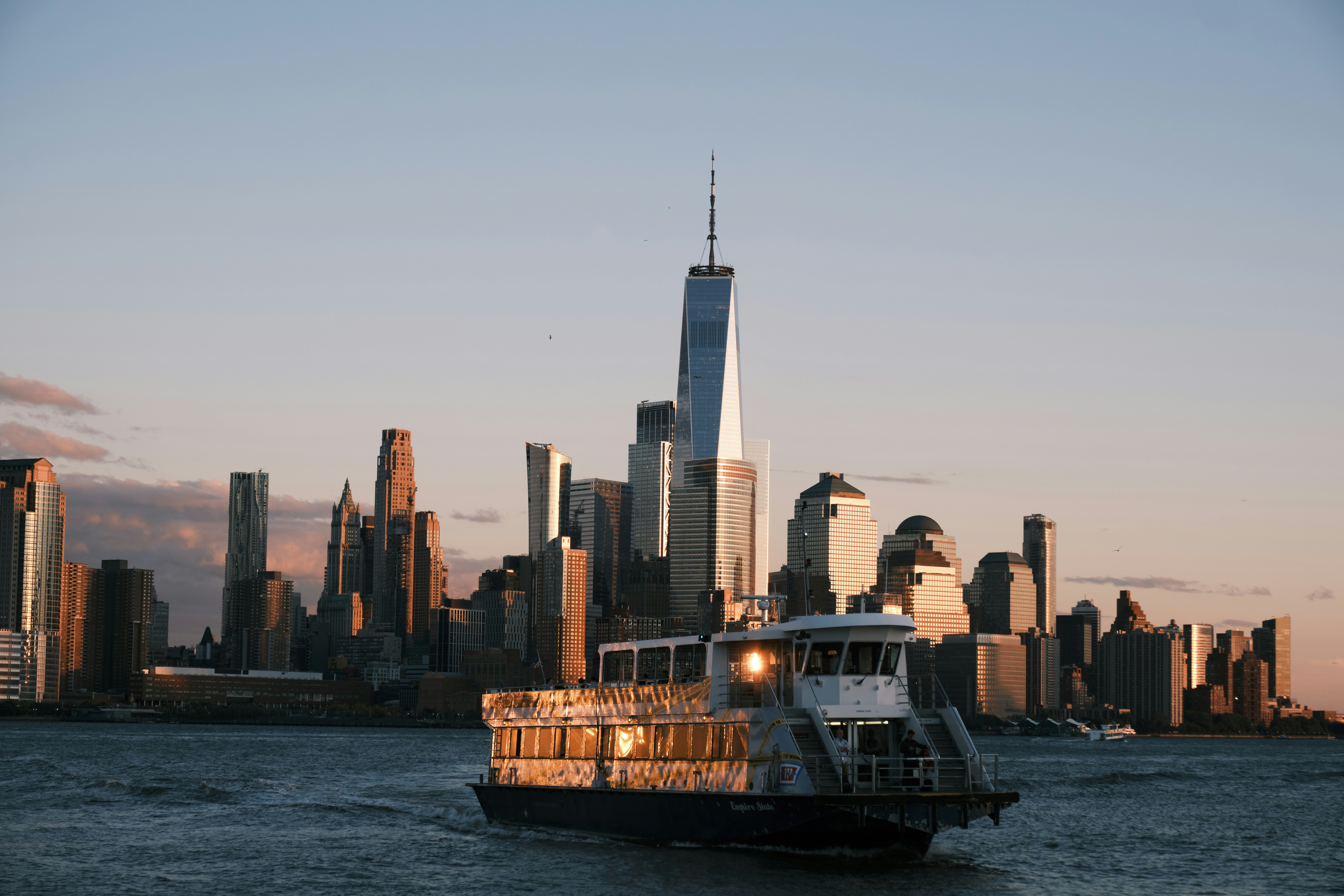 Sunlit Lower Manhattan from the Water: Ferry Crossing at Dusk