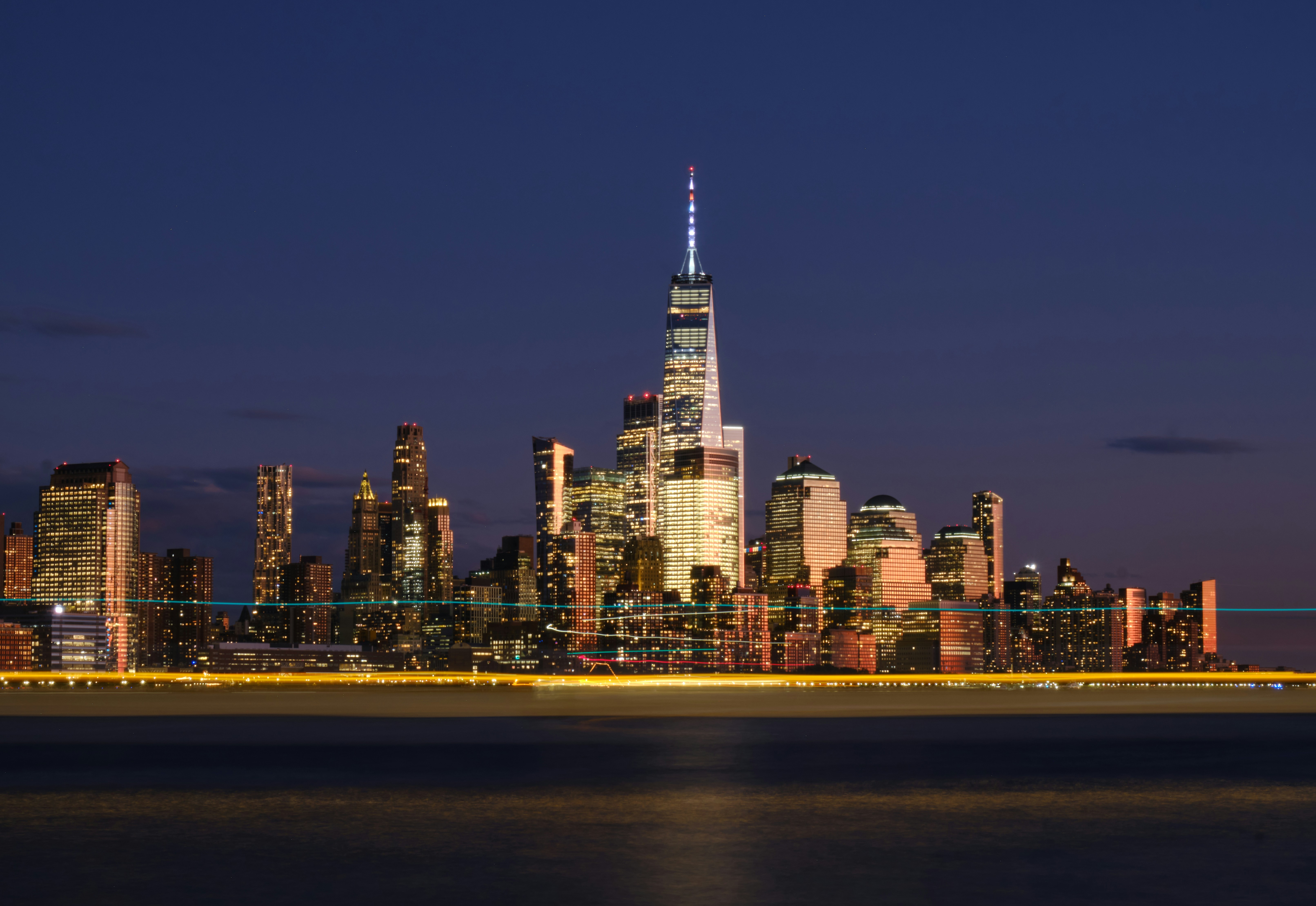 Midnight Spire: Manhattan Skyline Across the Water