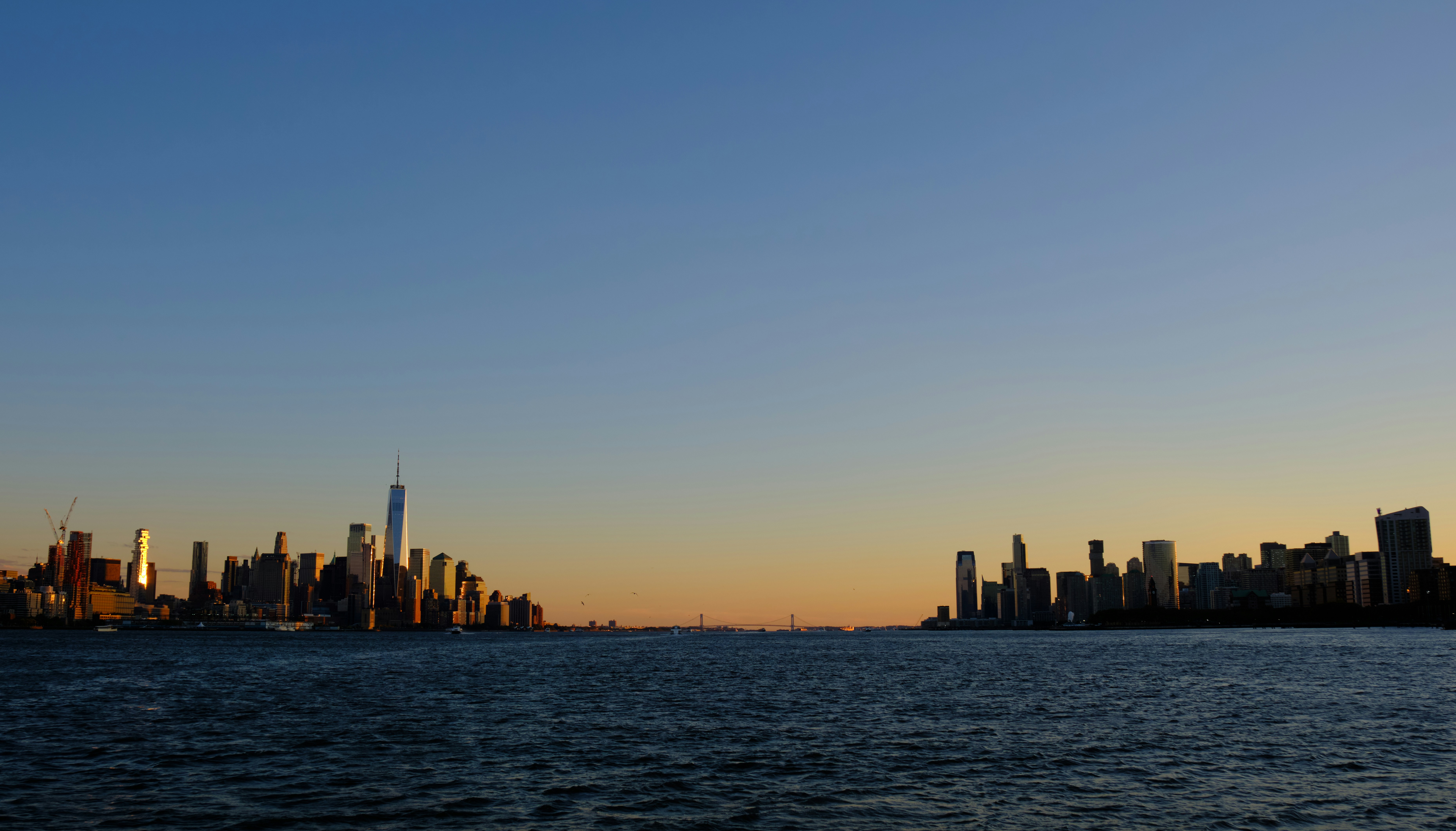 Dusk Over the Harbor: City Skyline Framed by Calm Waters