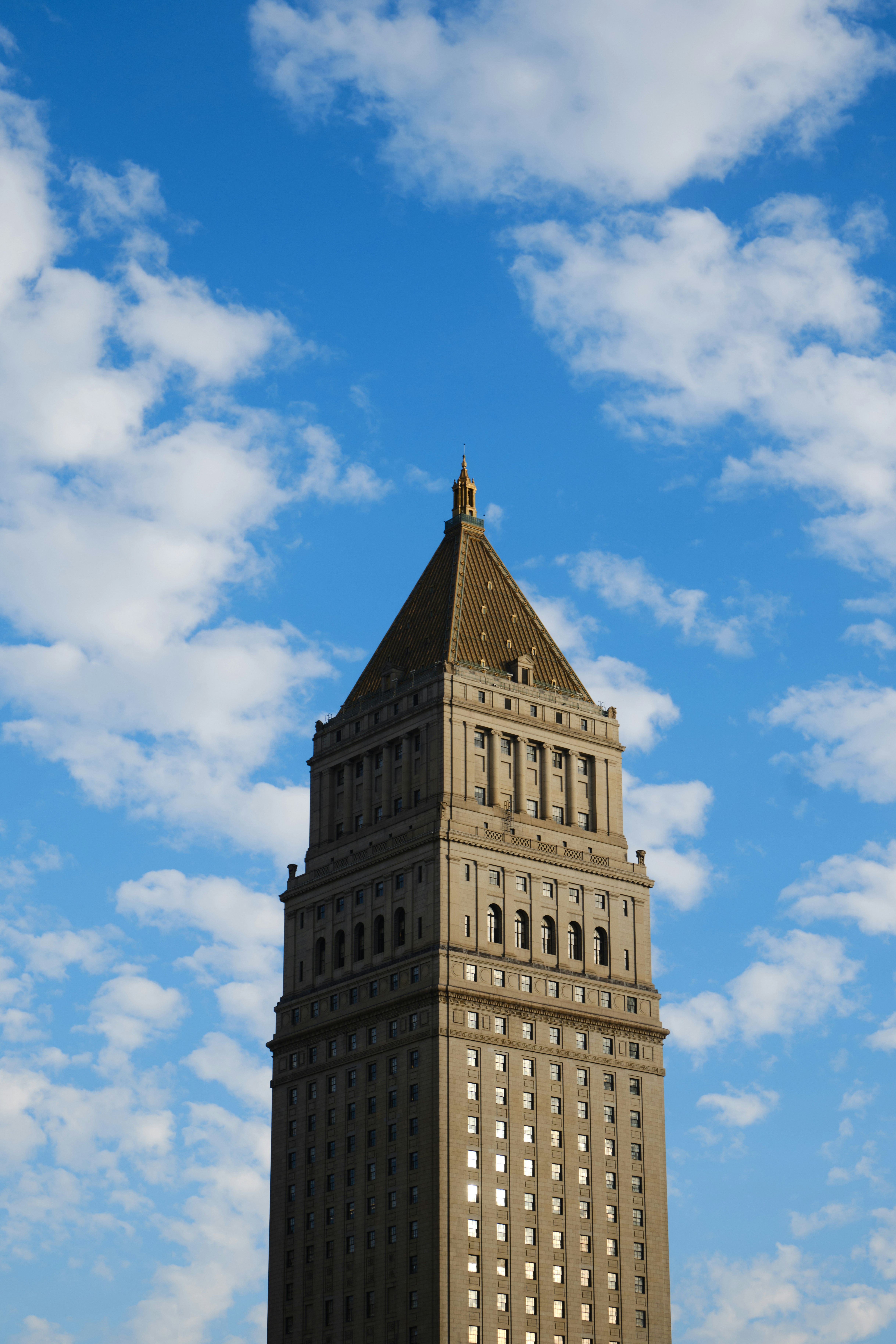 Beacon Above the City: A Tower Stands Under a Brilliant Sky