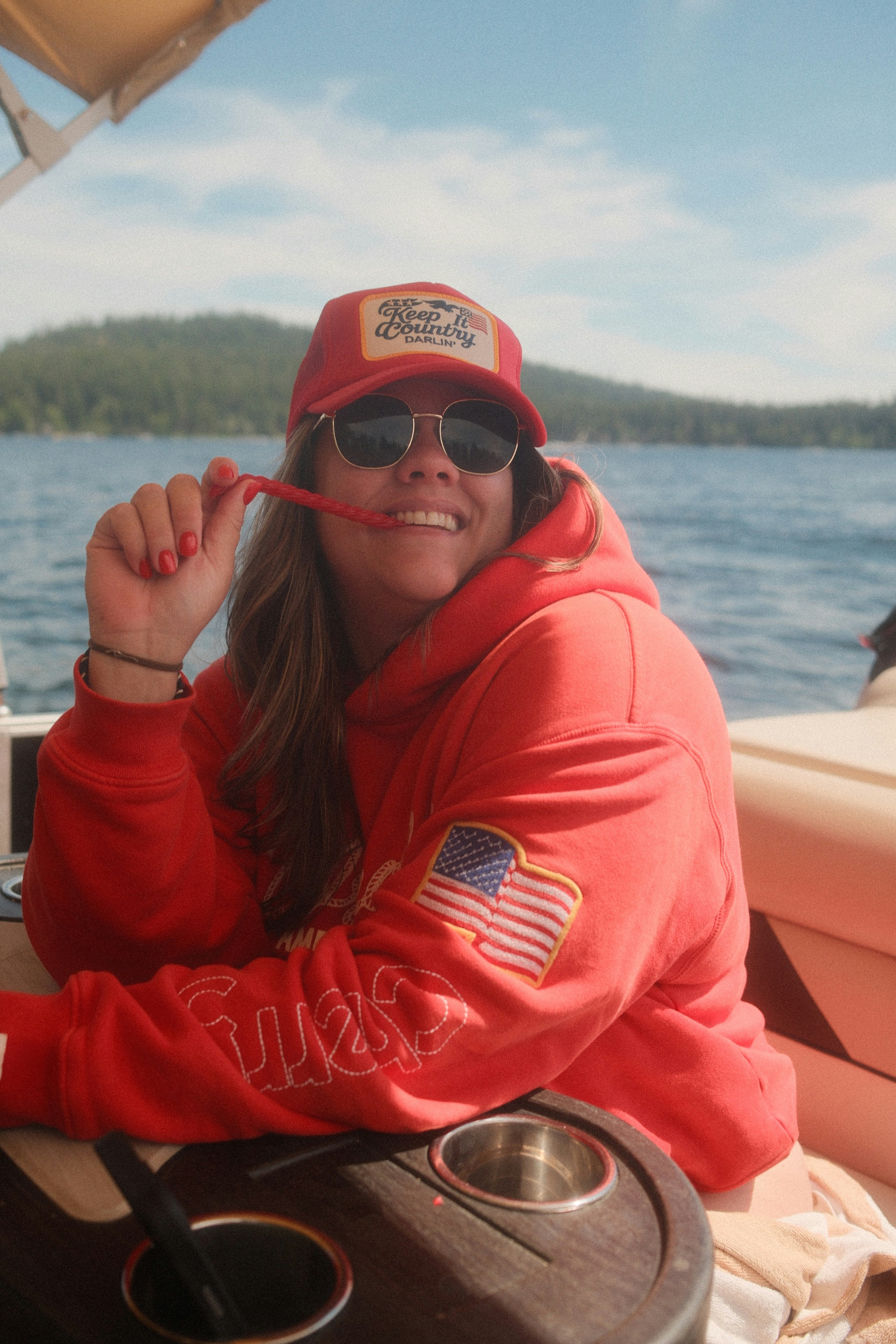 Red Hoodie, Ocean Breeze: A Relaxed Moment on a Lake Boat