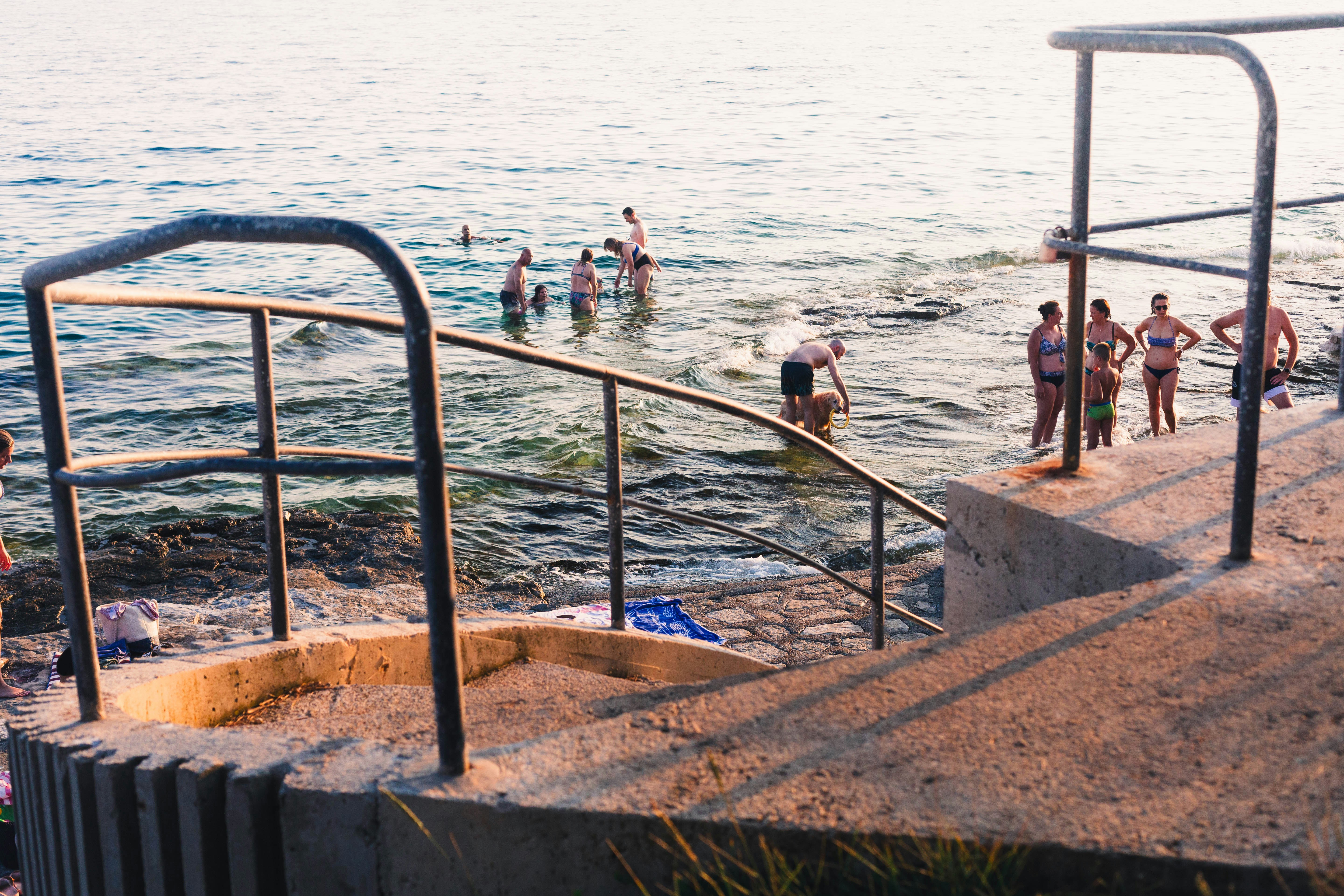 Sunlit Sea Steps: A Concrete Terrace Framing a Quiet Beach Scene